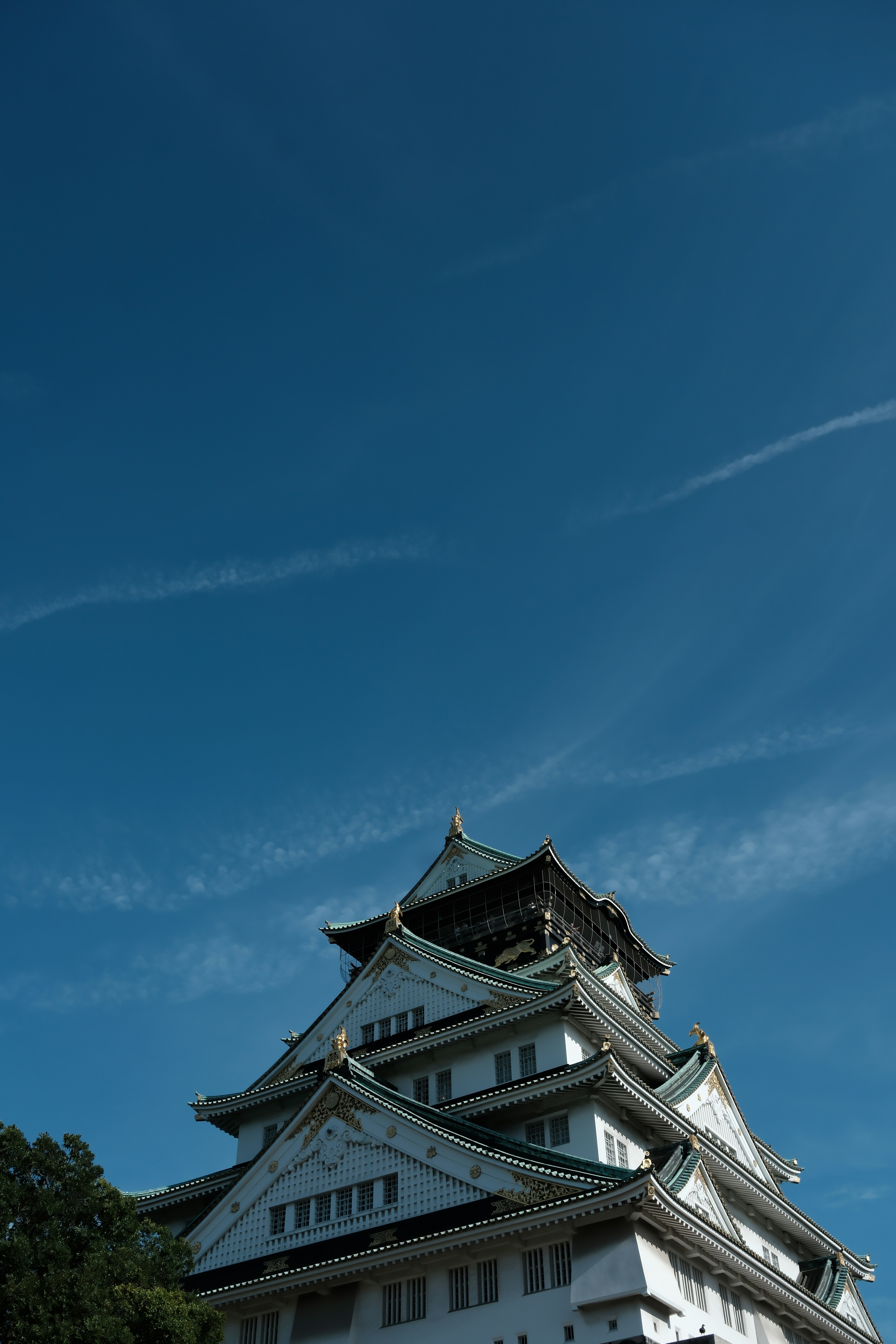 Majestic tiers: a Japanese castle pierces the blue sky