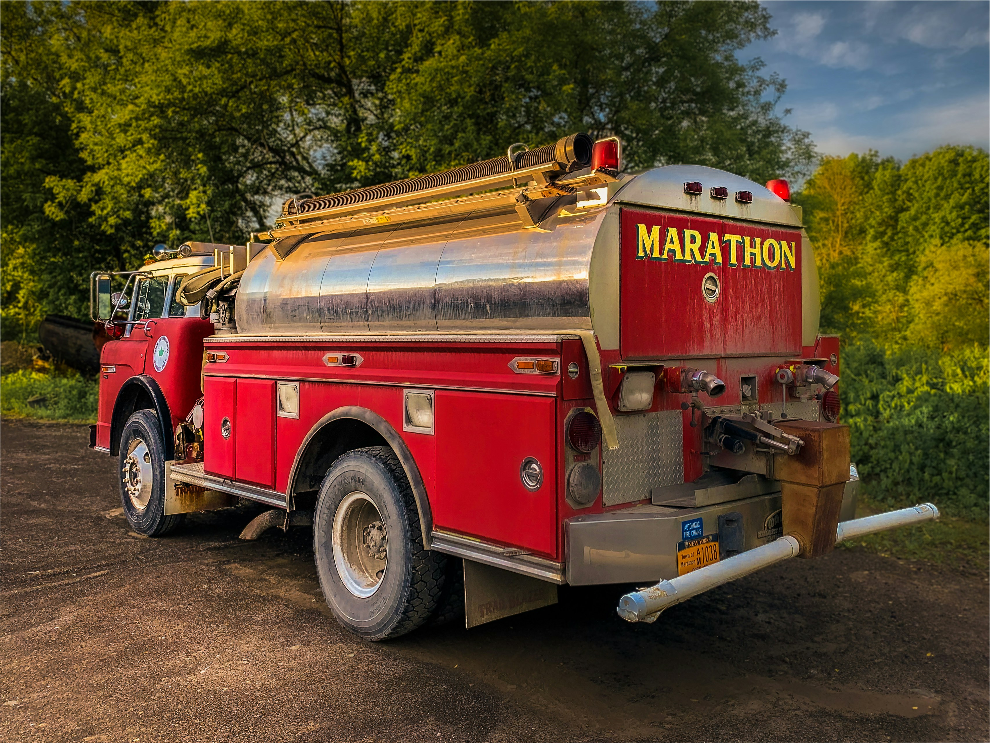 Red Giant: Back View of a Vintage Fire Engine in a Forest Clearing