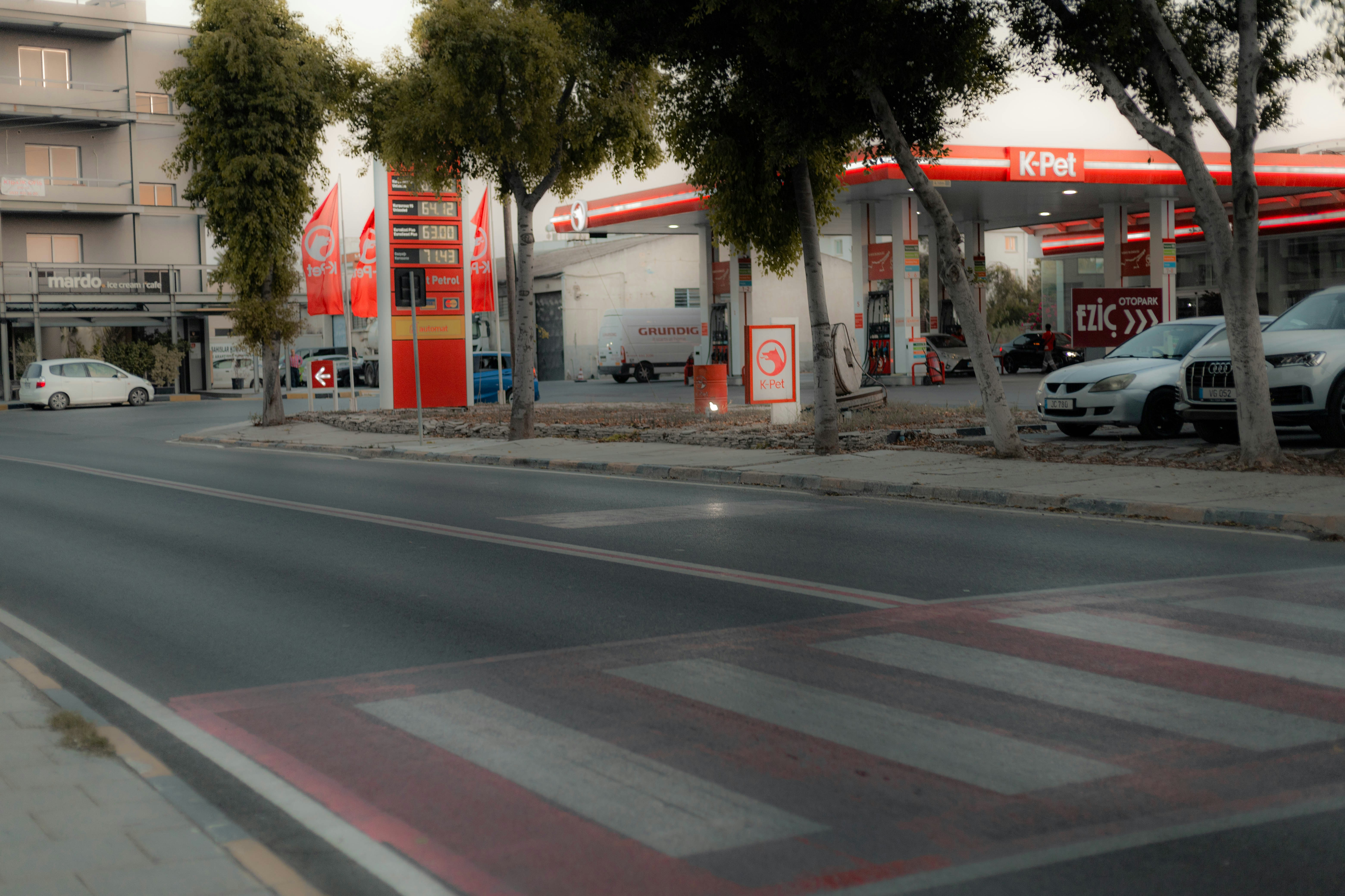 Red-Trimmed Gas Station Wake of Evening Traffic