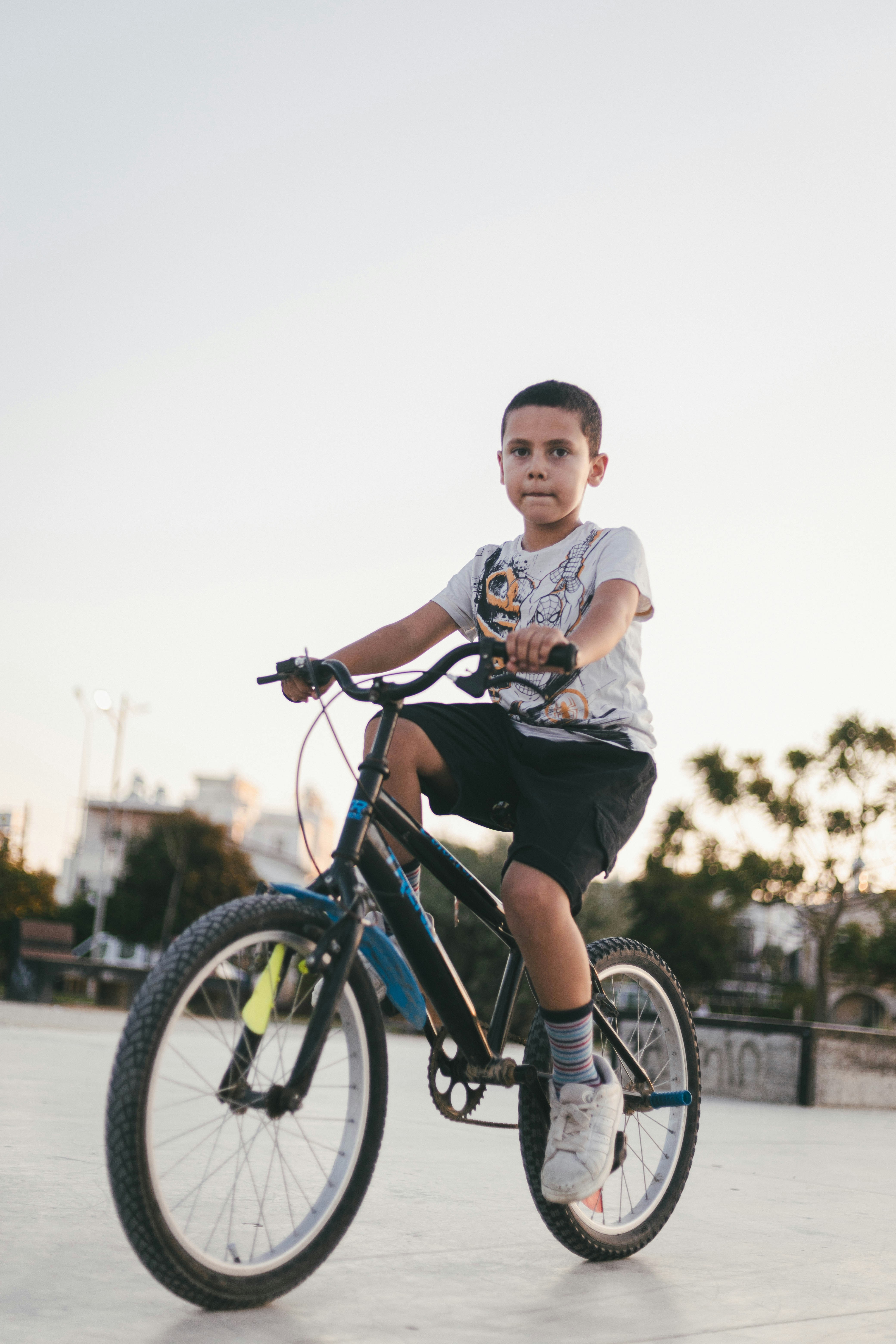 Youthful Balance: Boy on a Bicycle at Dusk