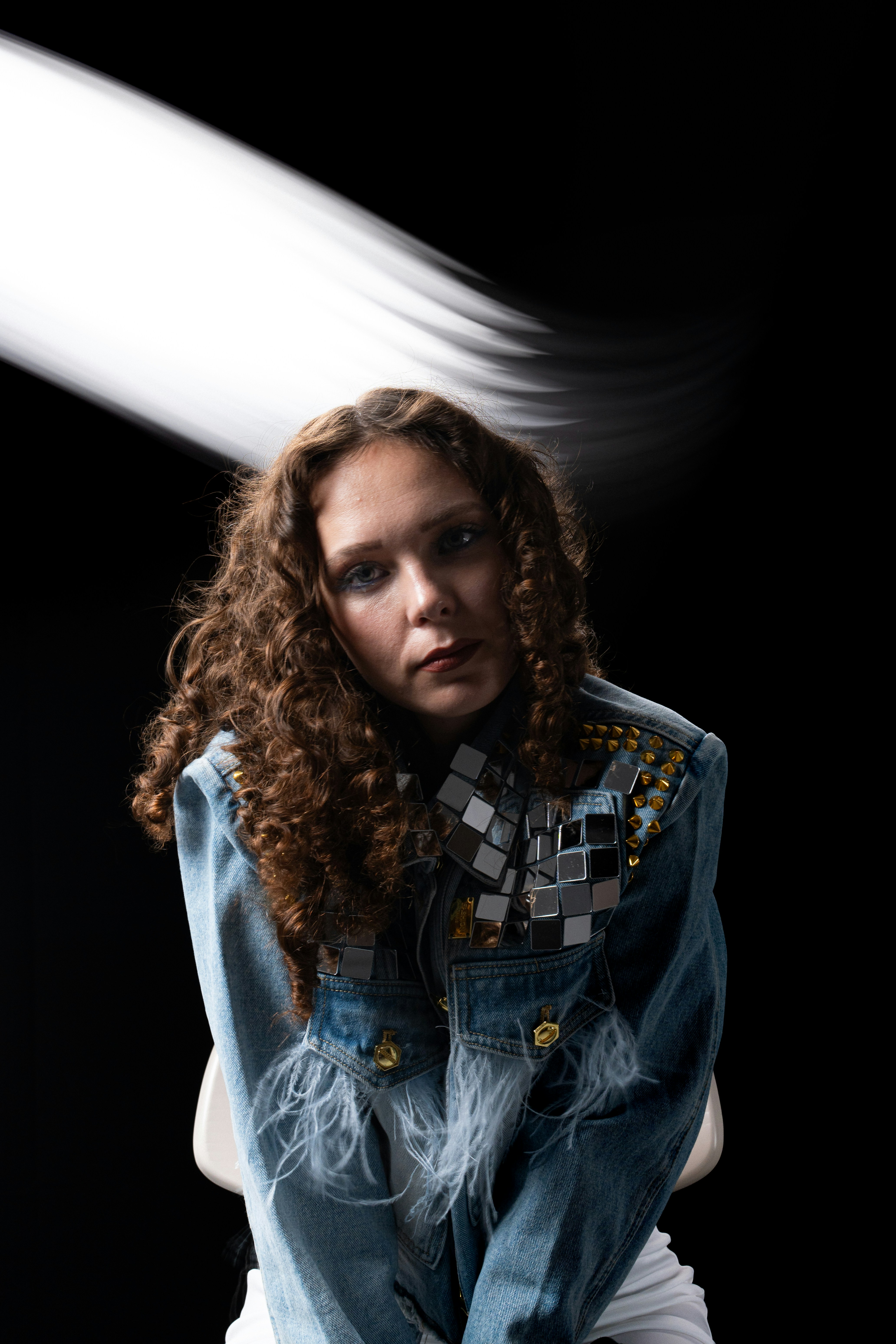 Motion in Quiet Focus: A Portrait with Moving Light and Denim Armor