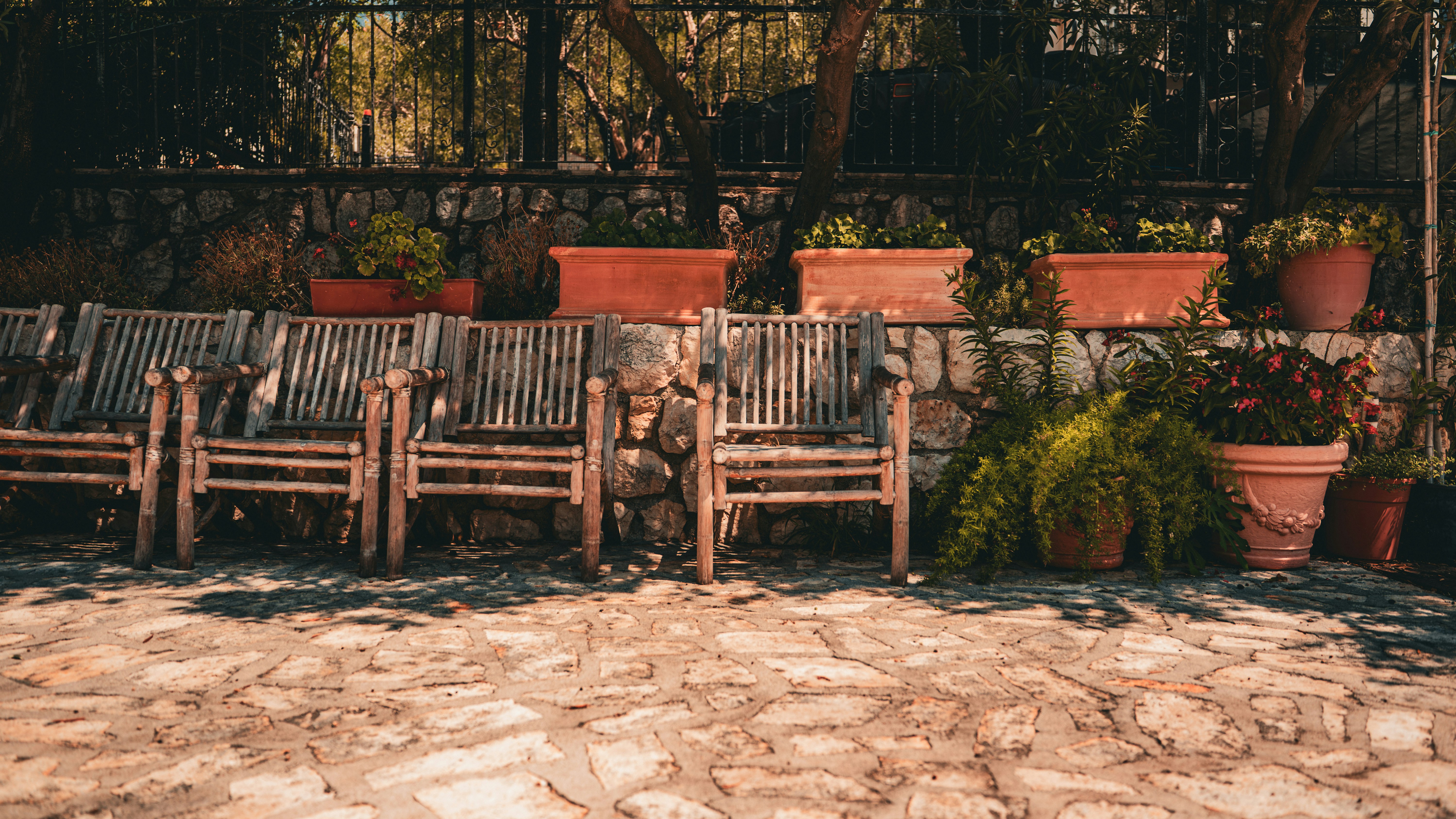 Stone Court of Quiet: A Row of Weathered Benches Under Warm Garden Light