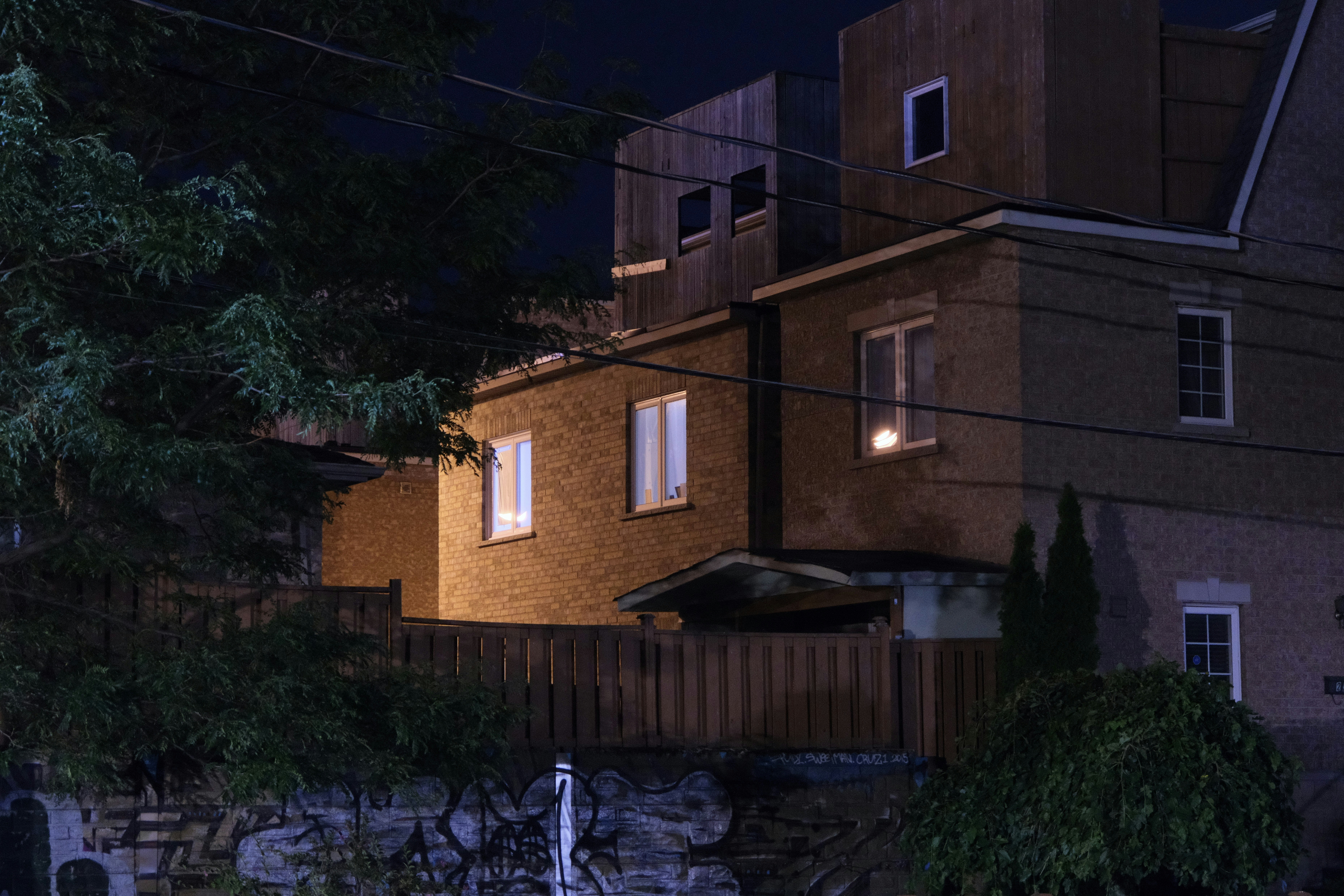 Warm Window Light Against Nightfall Brick Facade