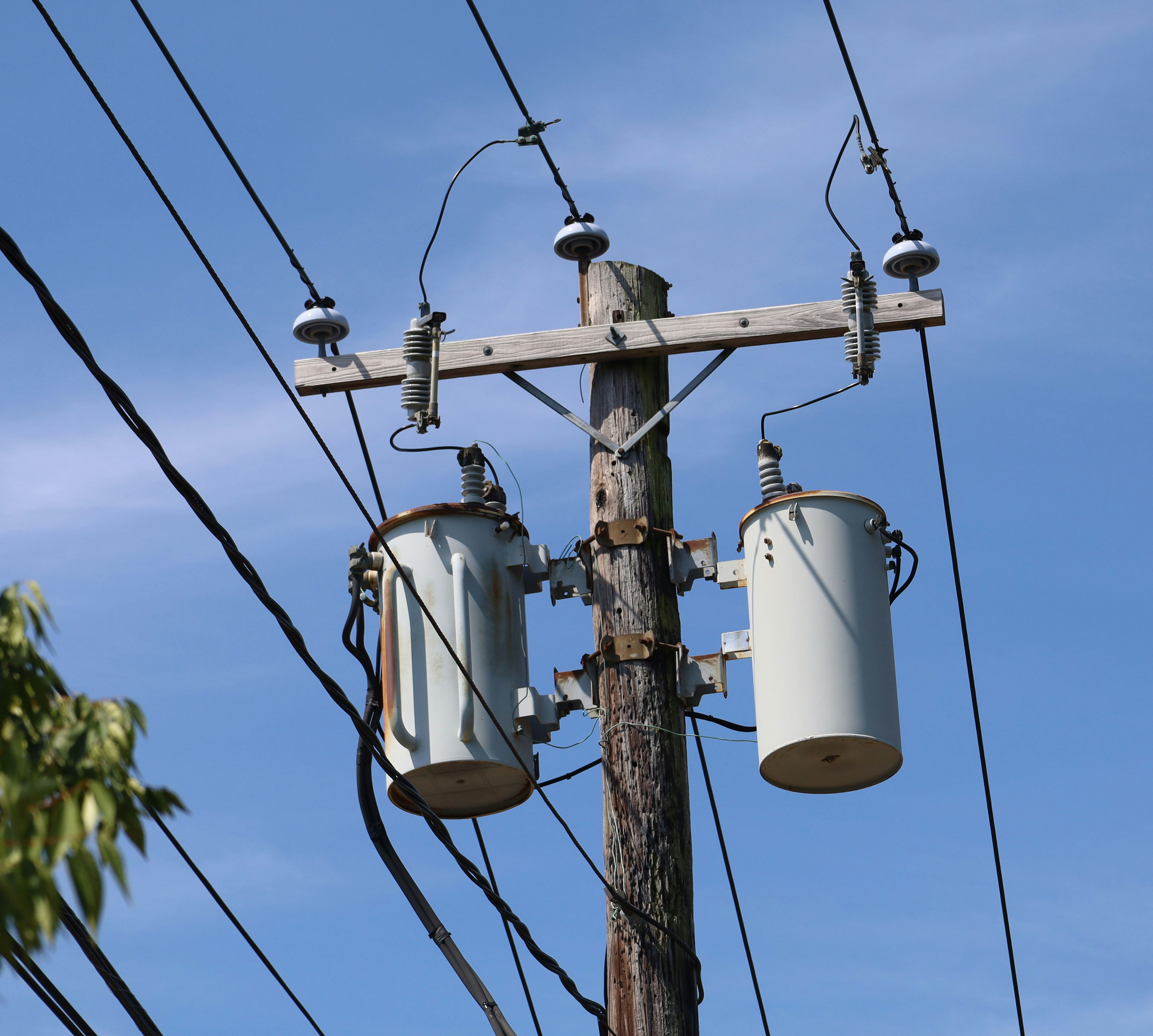 High Voltage Silence: A Wooden Pole Between Wires