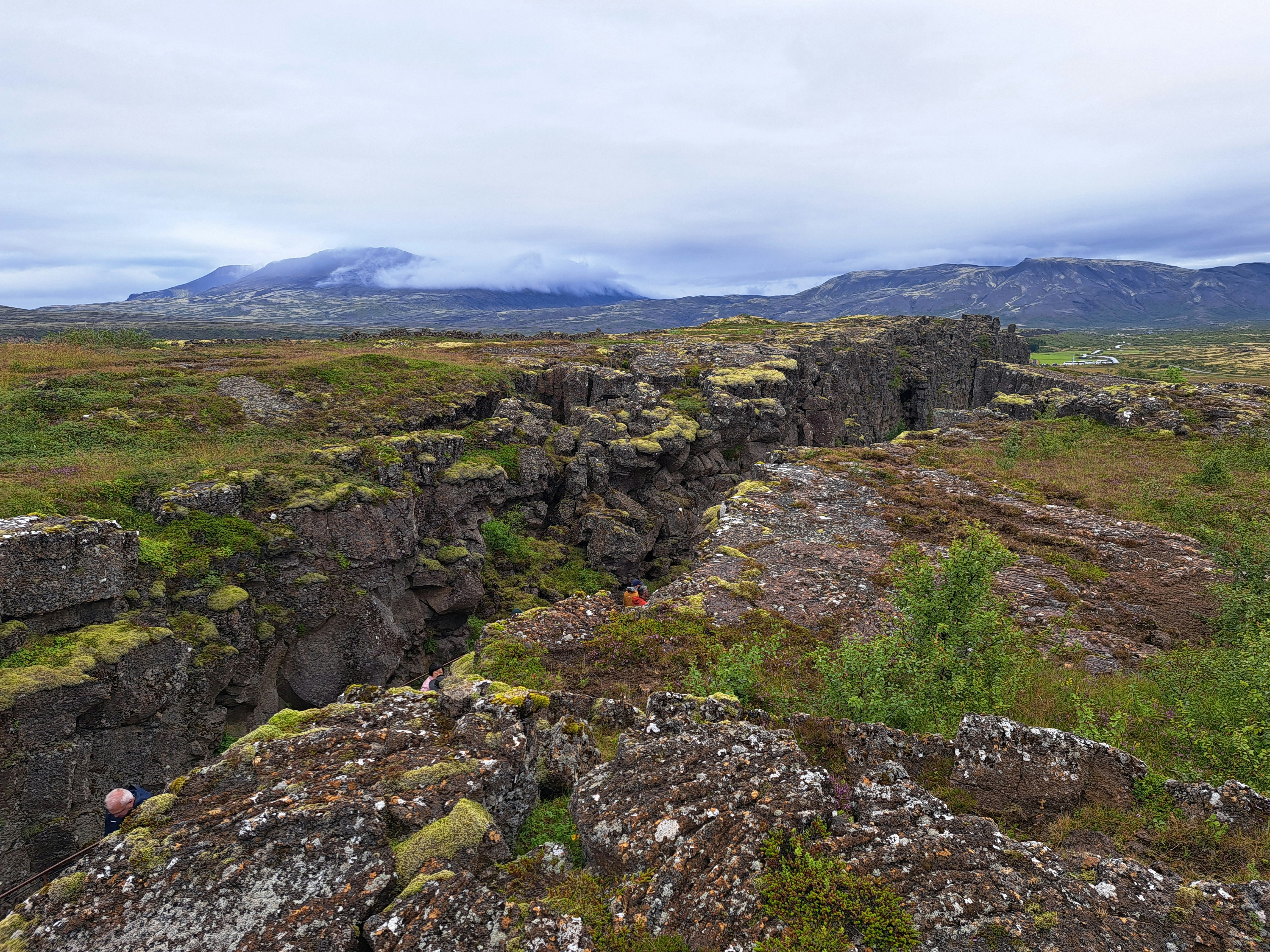 Rugged Rift: Mossy Basalt Cascades under a Cloud-kissed Plateau