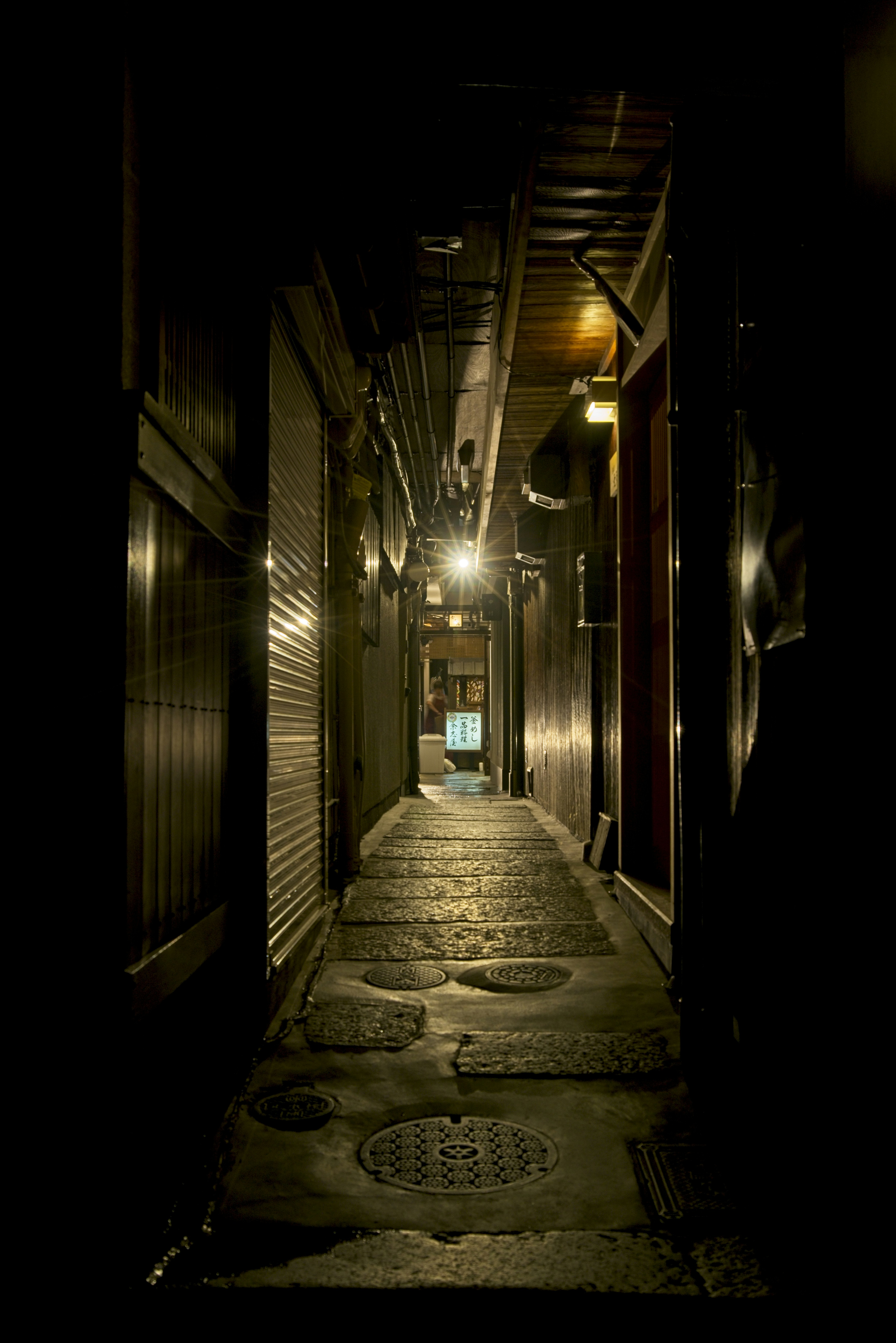 Lamplit Alley: A Narrow Corridor Toward a Quiet Doorway