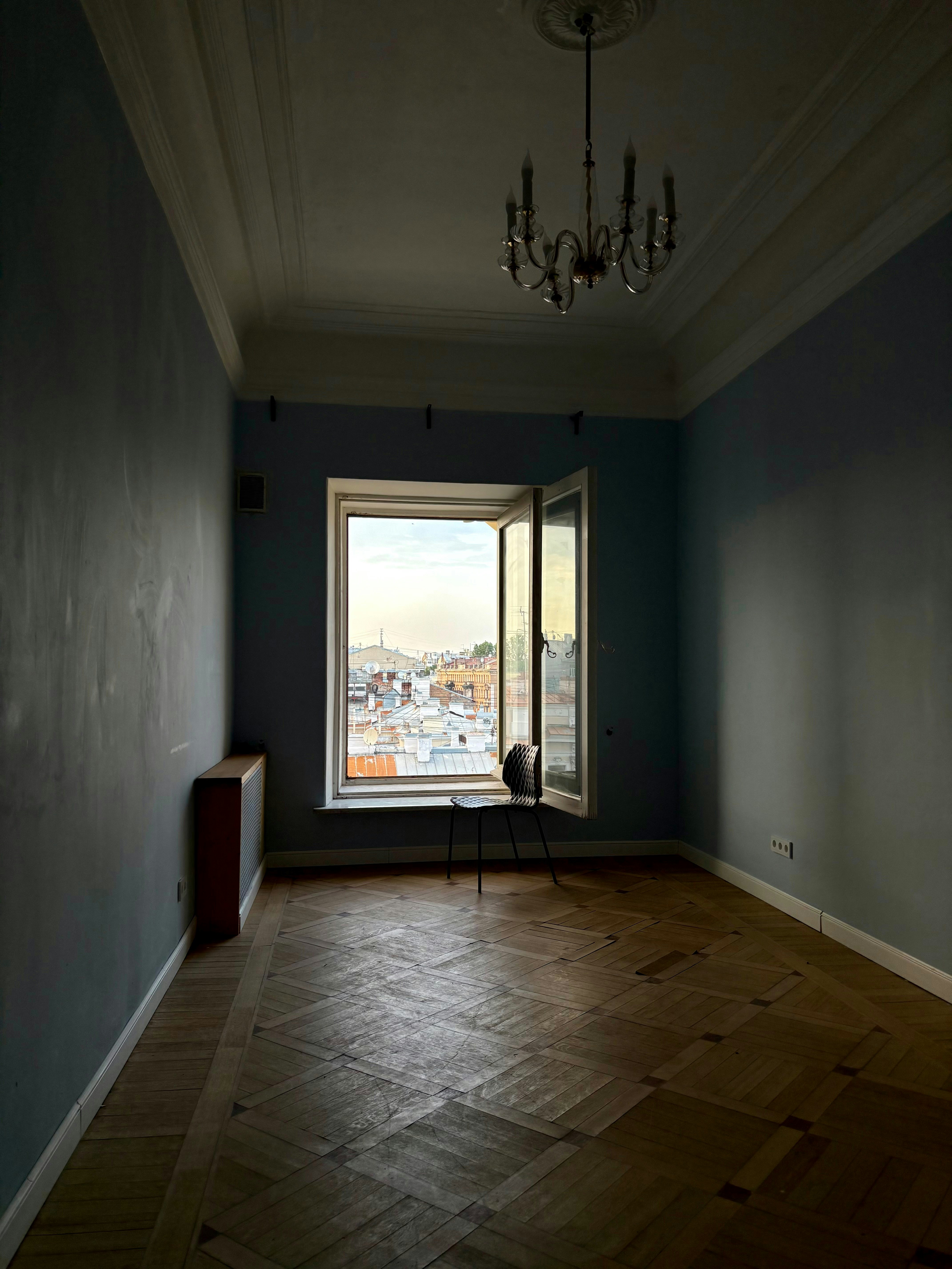 Window to a Quiet City Inside a Dim Blue Room