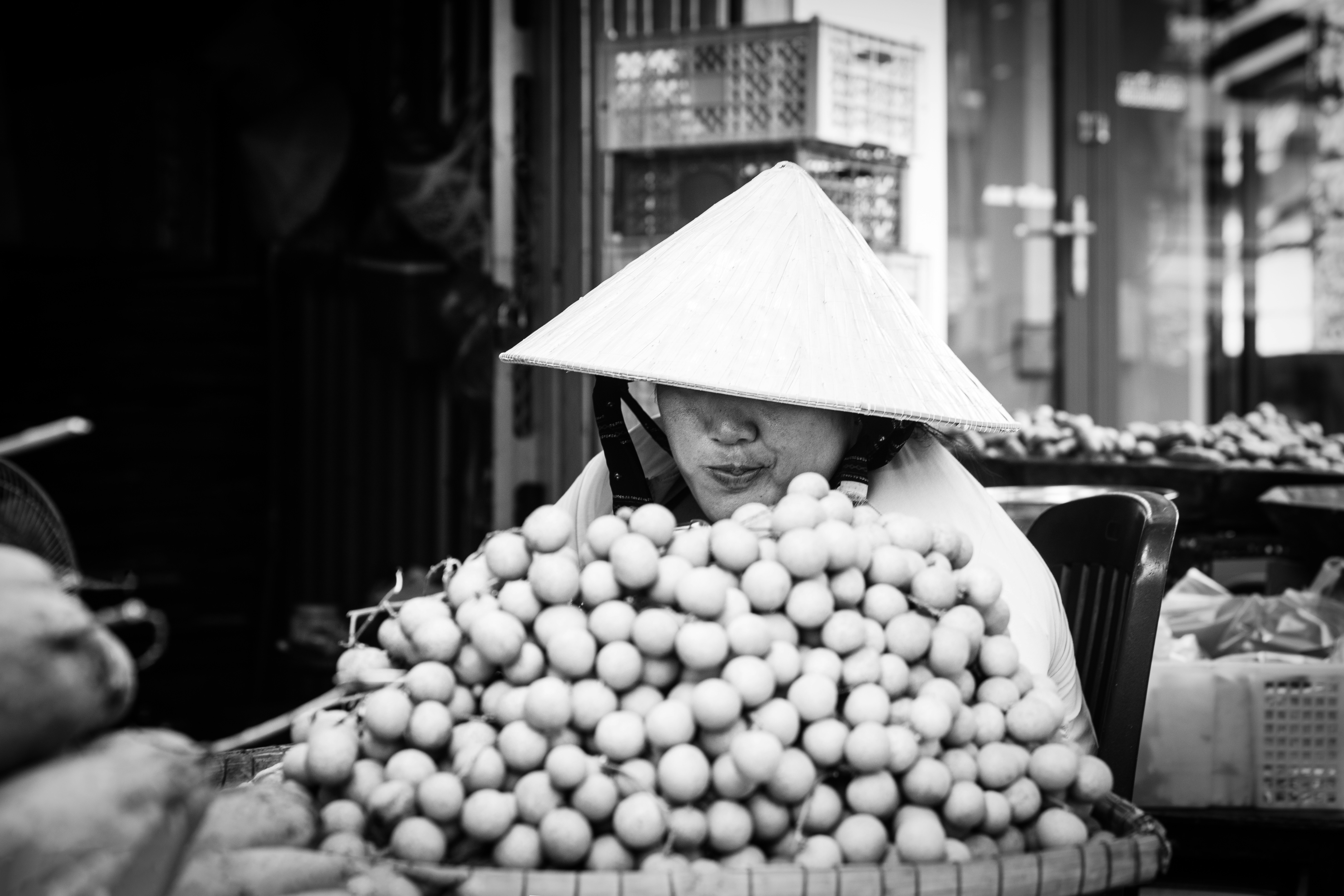 Conical Hat Seller Surrounded by a Mountain of Orbs