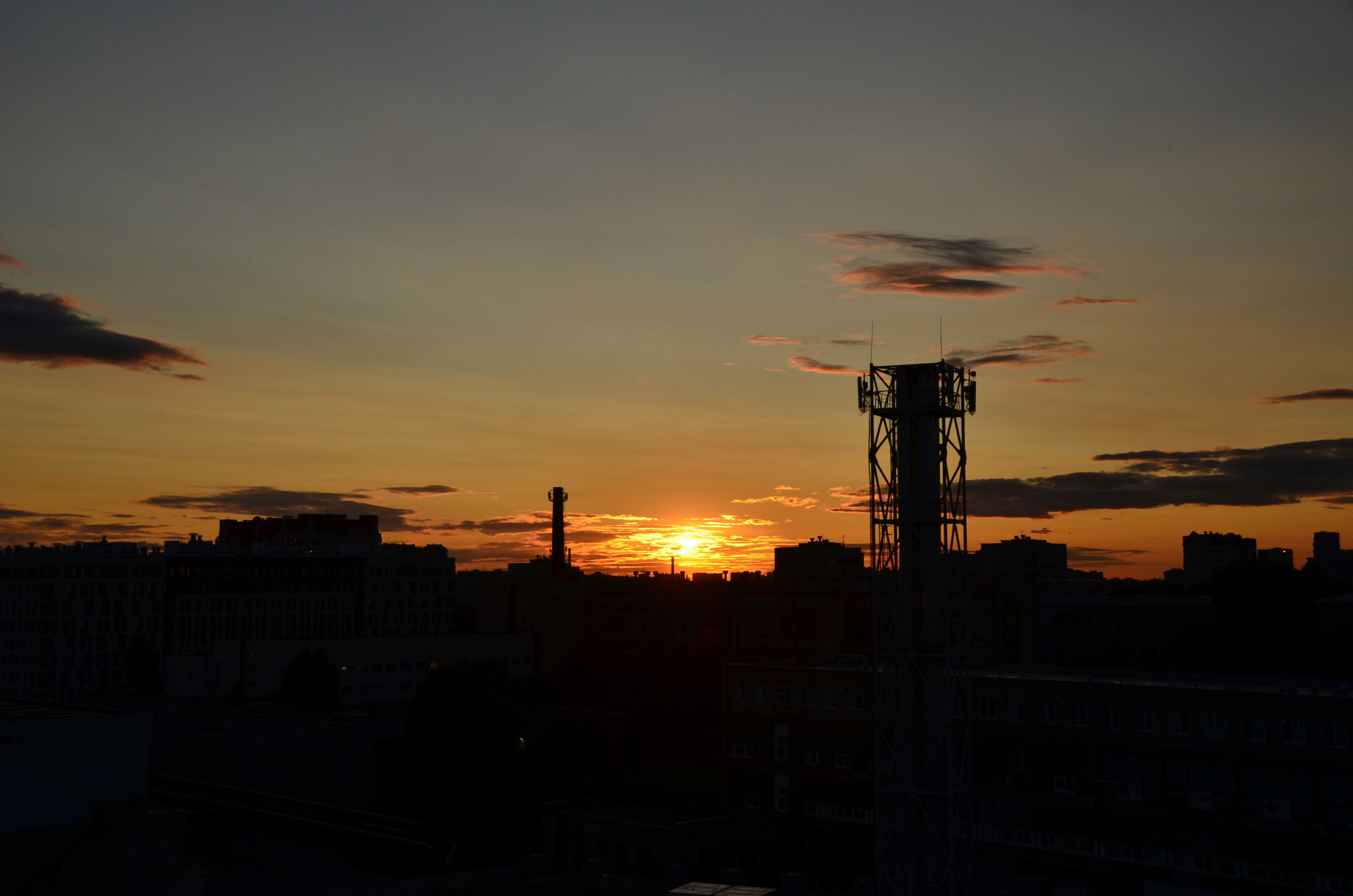 Sunlit Skyline: Silhouette Tower Beneath a Quiet Dusk