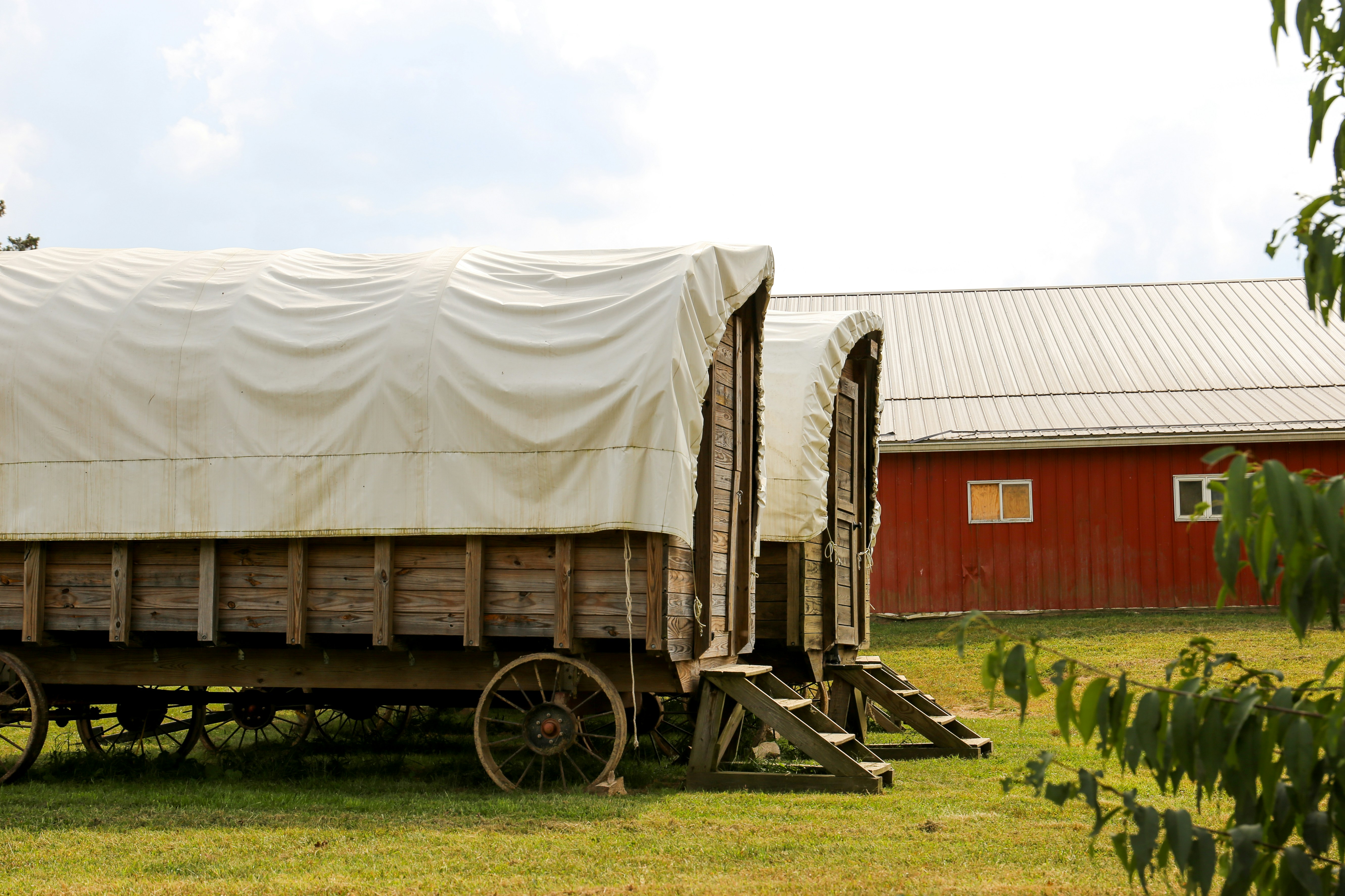Covered Wagon at Distant Red Barn
