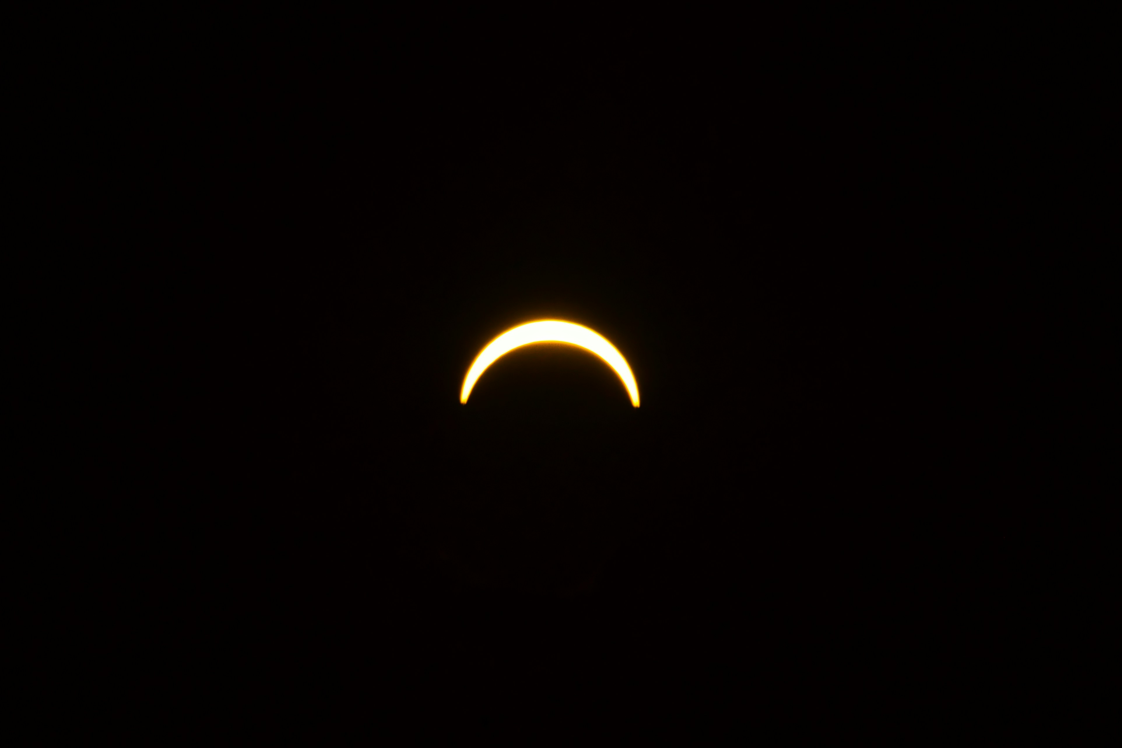 Halo of Dawn: A Lunar Eclipse Curve Emerges from Darkness