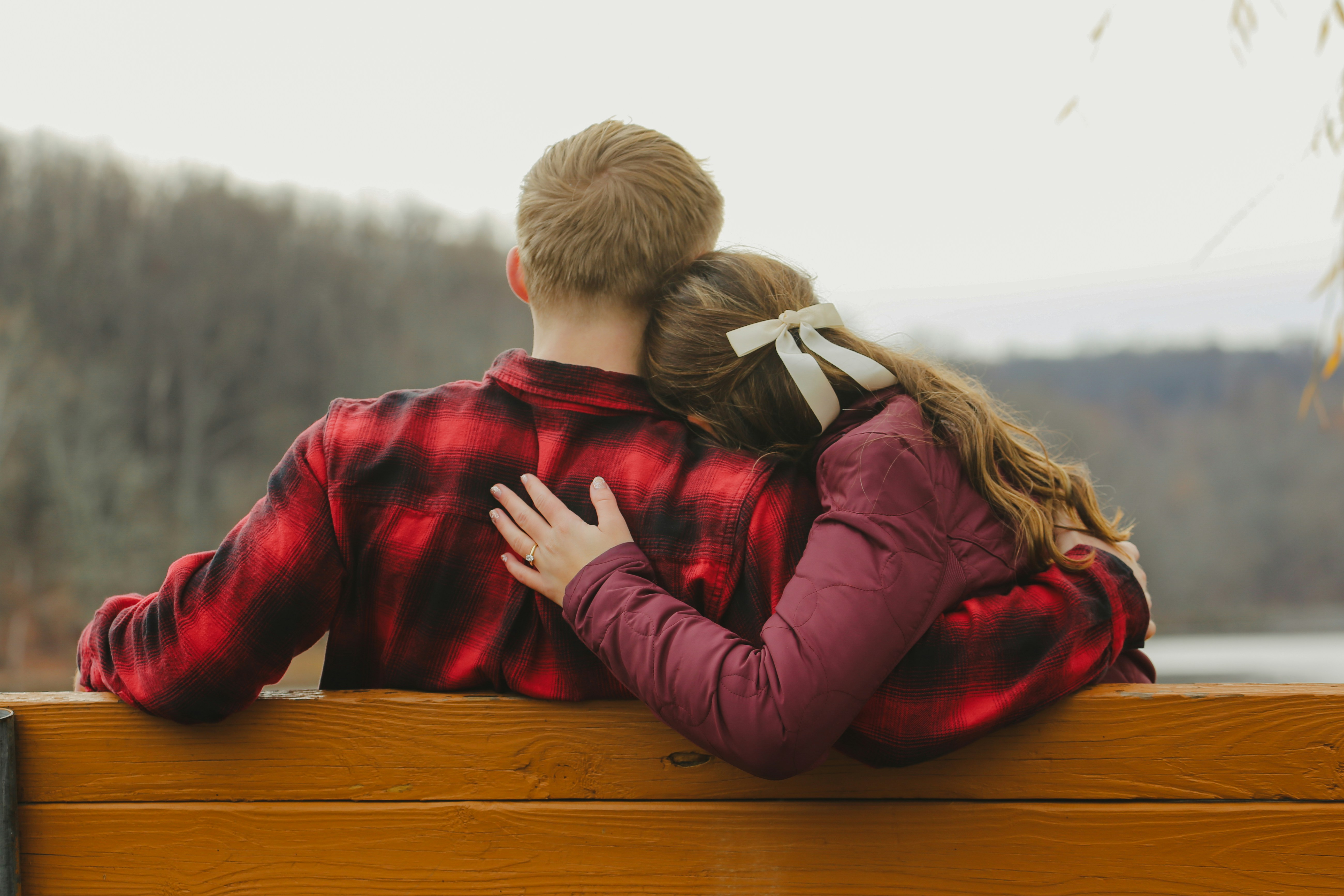 Two Lovers on a Railing: A Quiet Embrace by the Lake