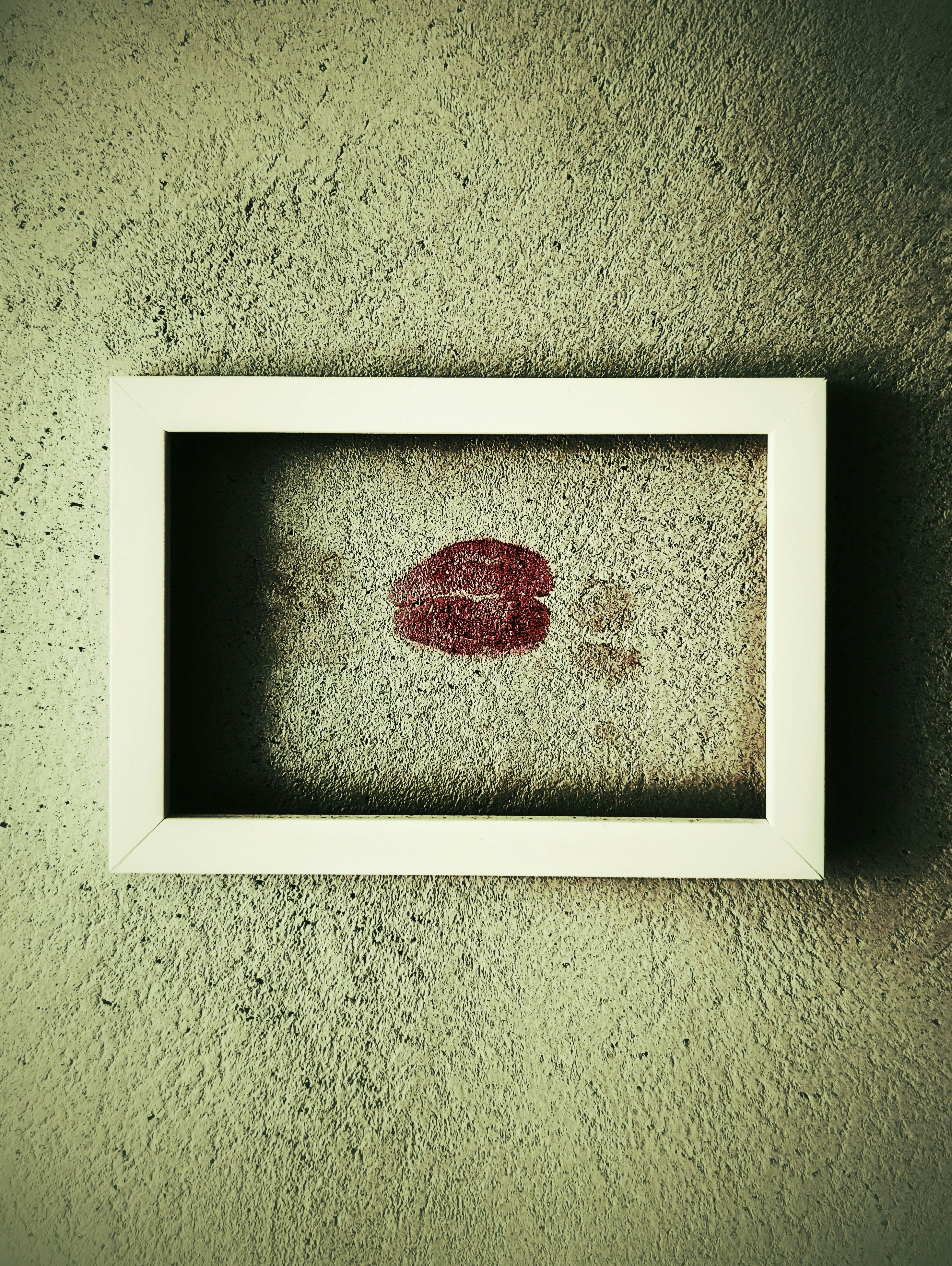 Framed kiss imprint in a grainy art piece