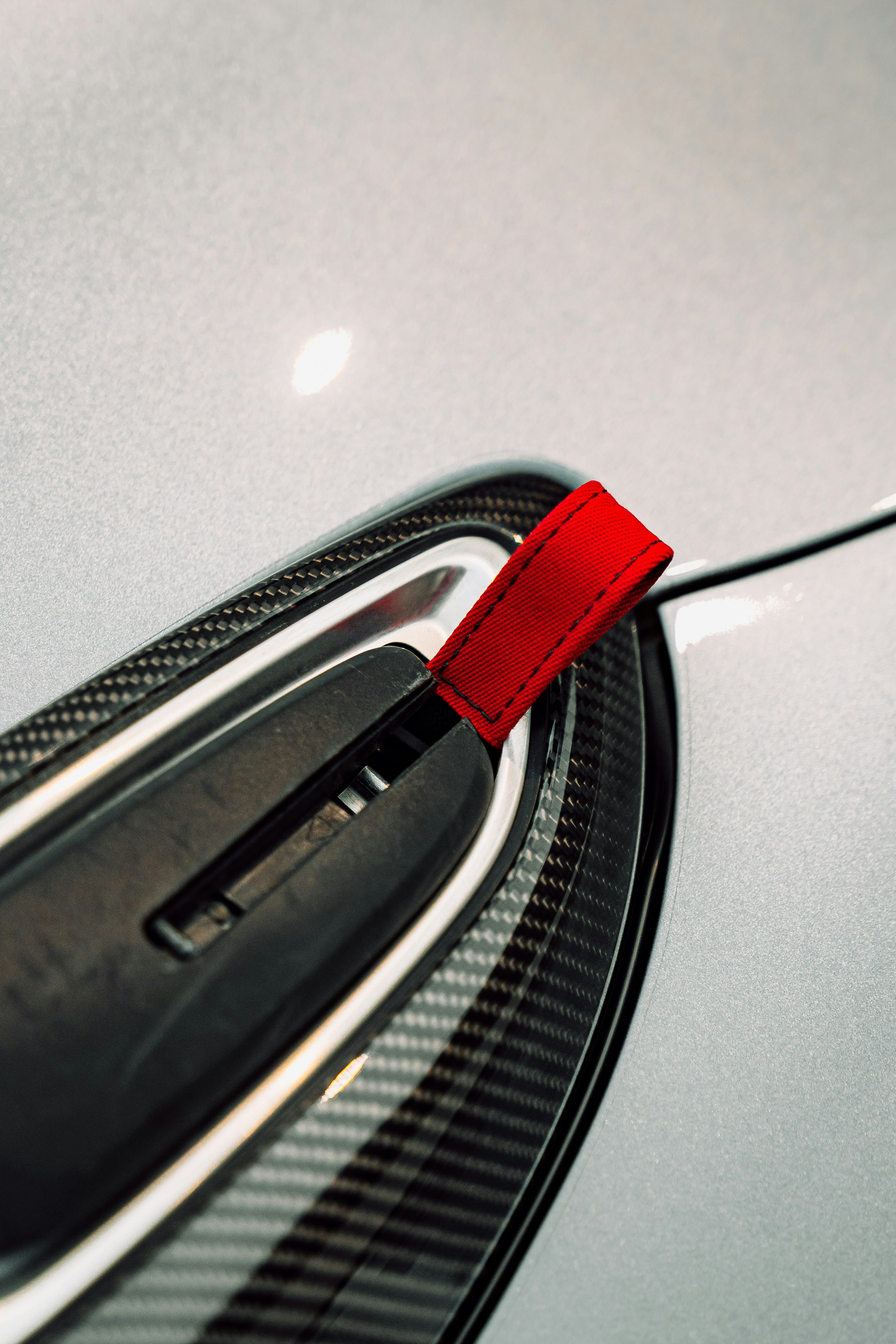 Red Strap on a Carbon-Caded Lens Cap