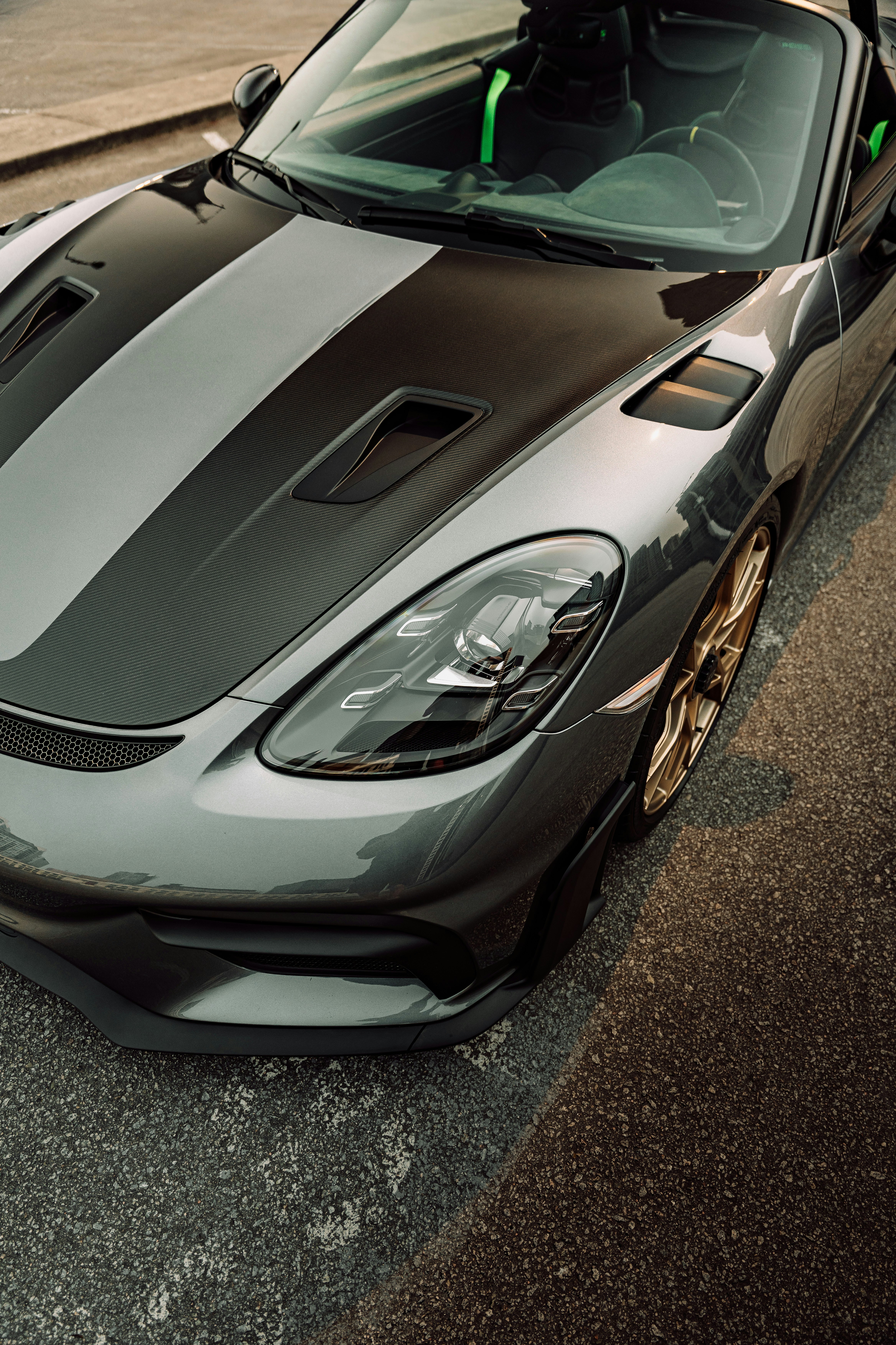 Chiseled front-left view of a carbon-accented Porsche-like sports car
