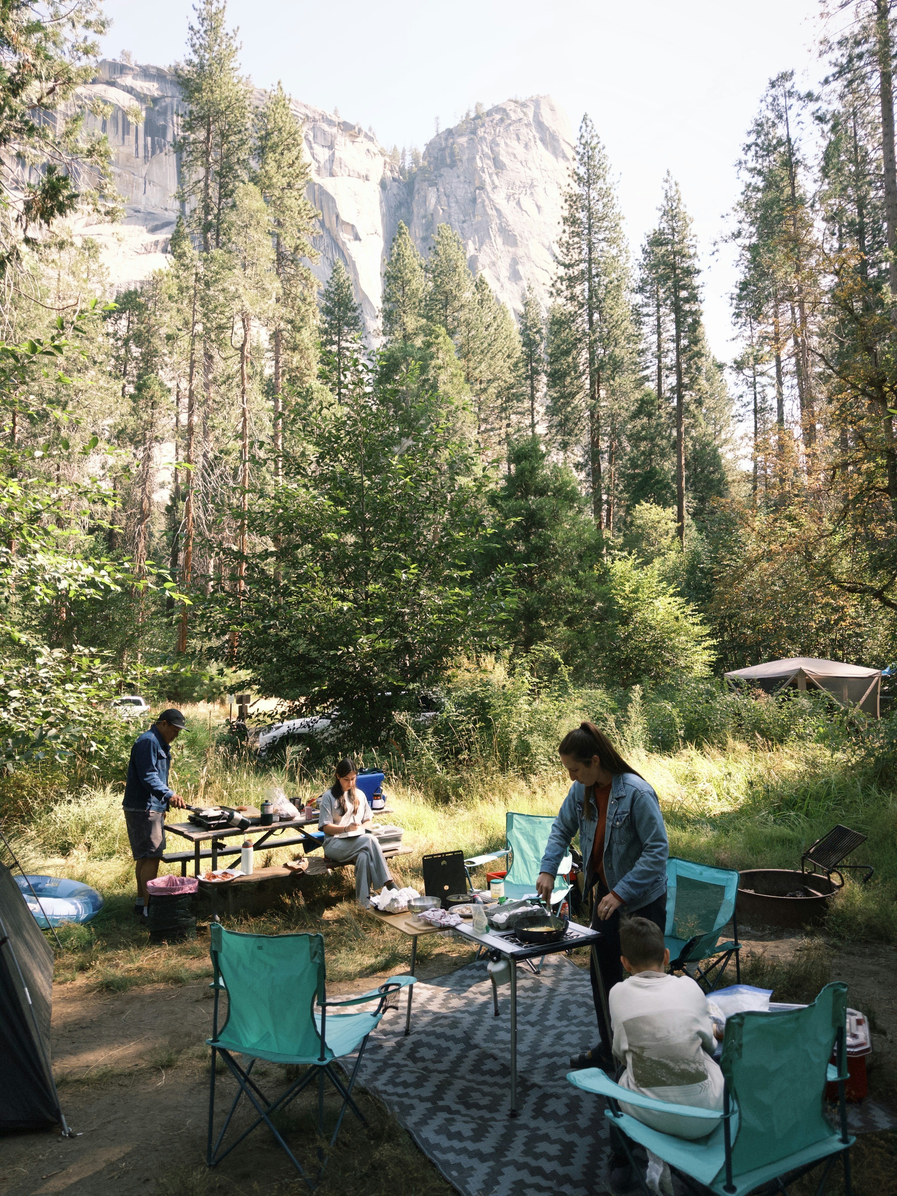 Camping Feast Under Pines: A Family Gathering by the Campfire
