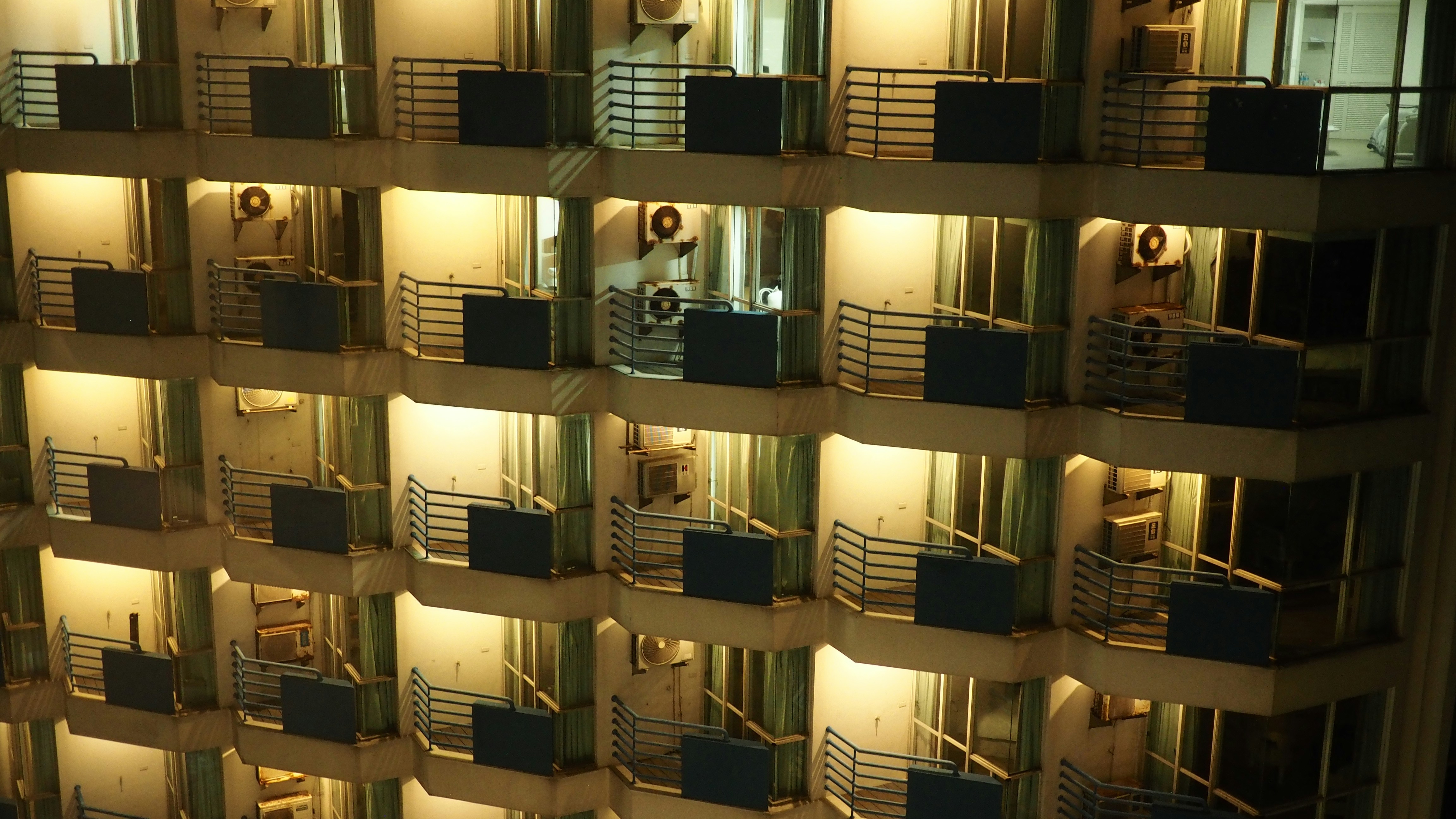 Nighttime Grid: Repeating Balconies Glow Like Luminous Windows