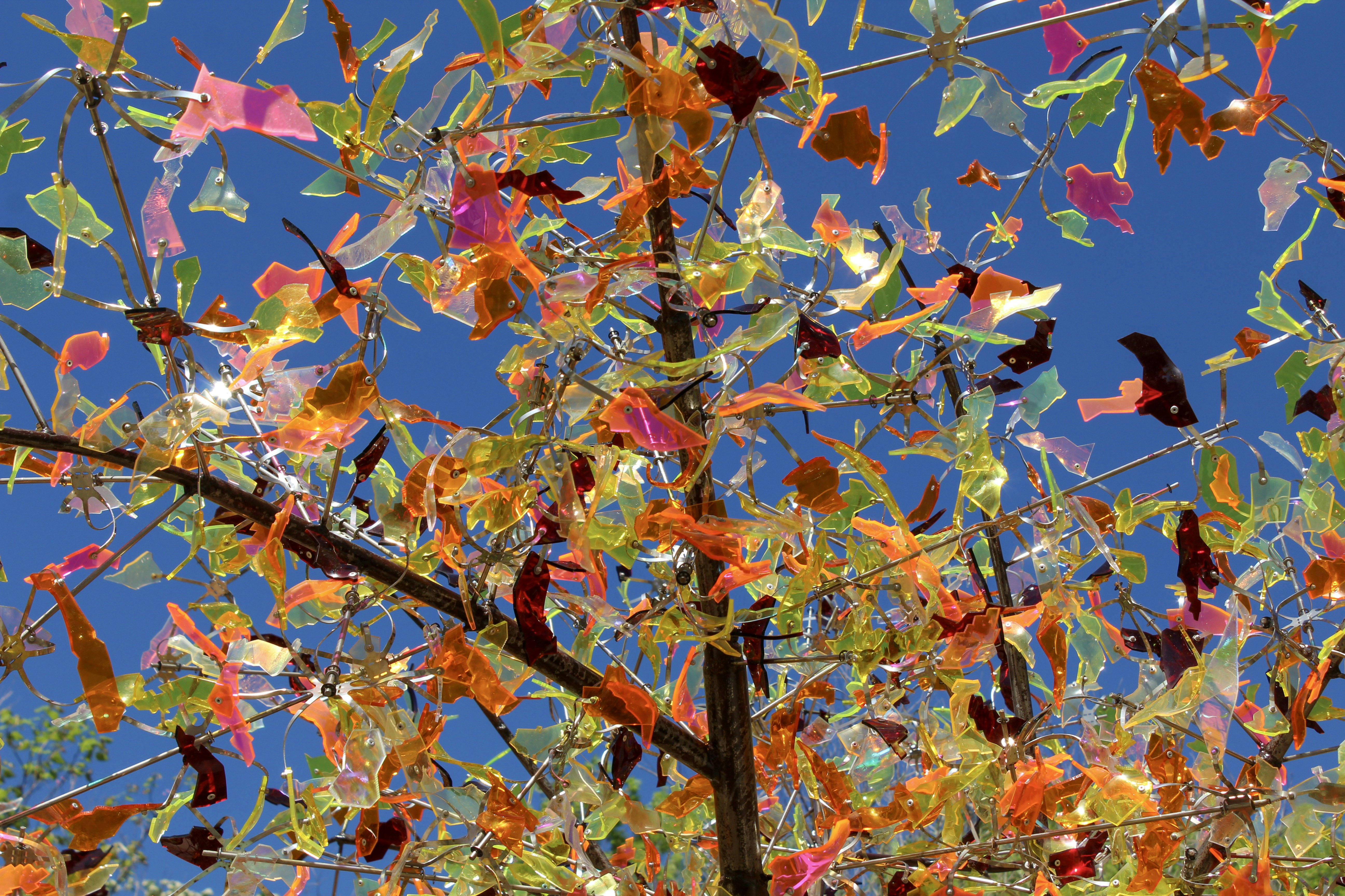Colorful Confetti Canopy Against a Clear Blue Sky