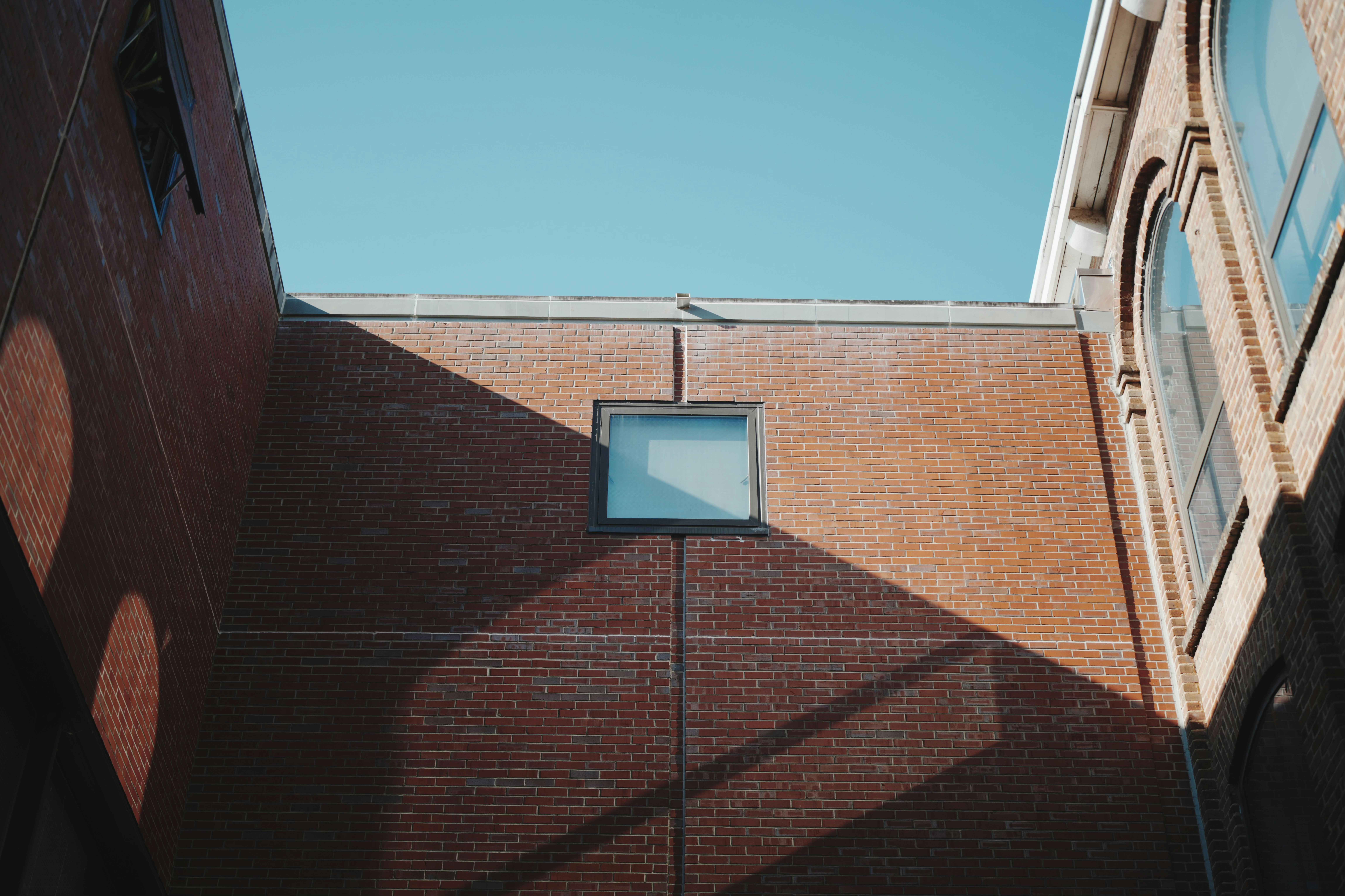 Sunlit Brick Facade and Shadowed Geometry