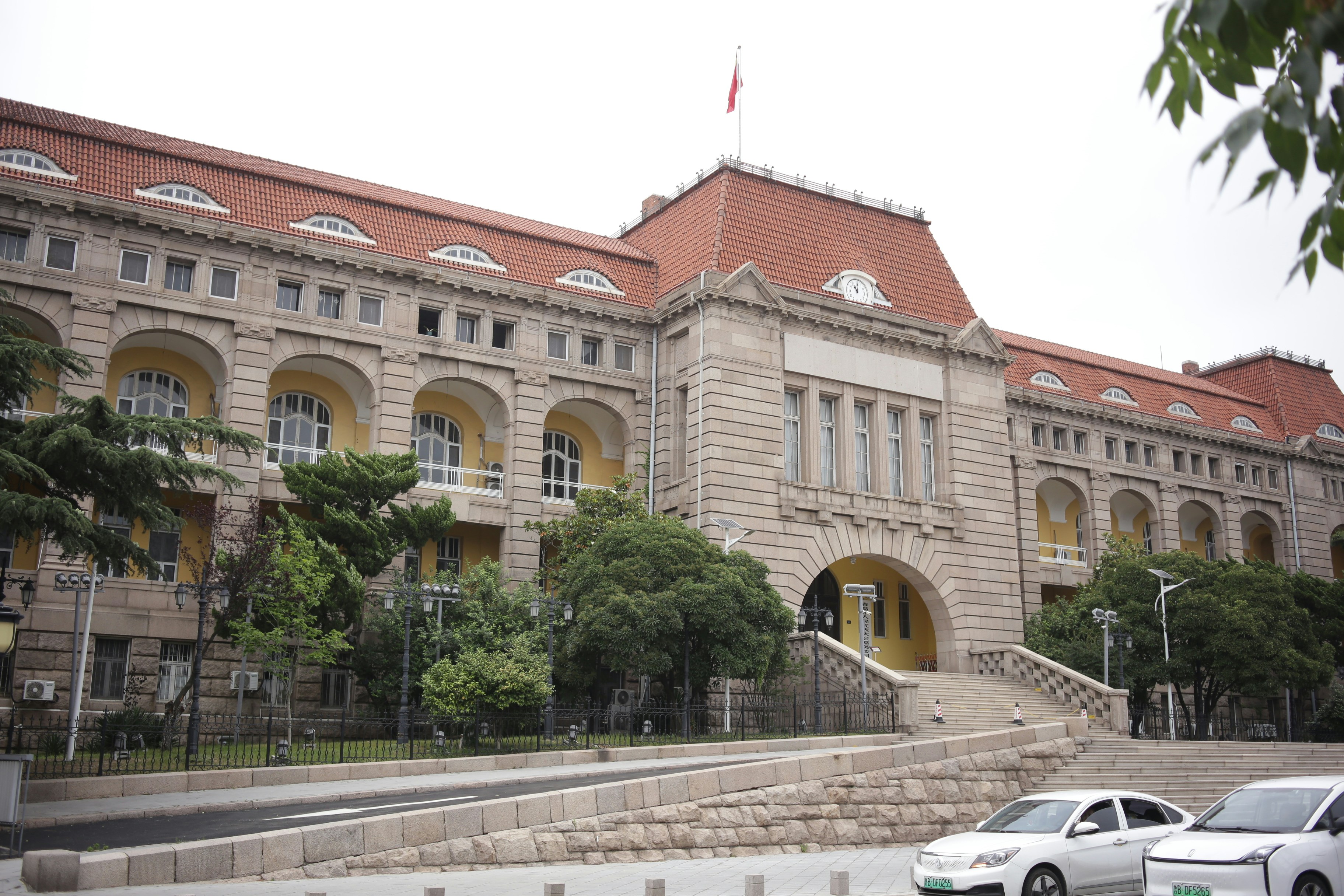 Arched Campus Facade: A stately stone building framed by greenery