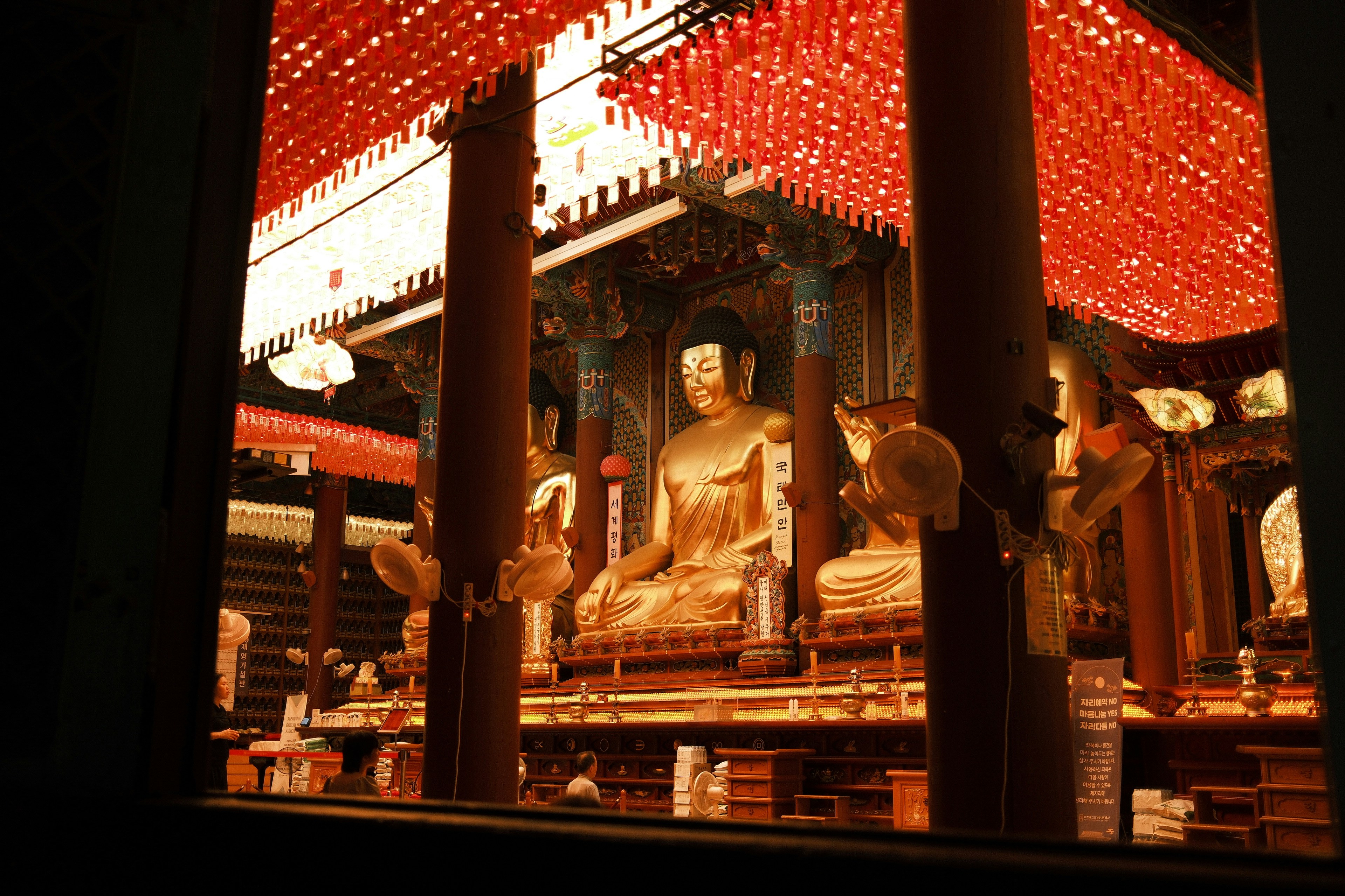 Golden Temple Reverie: A Buddha Amid Red Lanterns