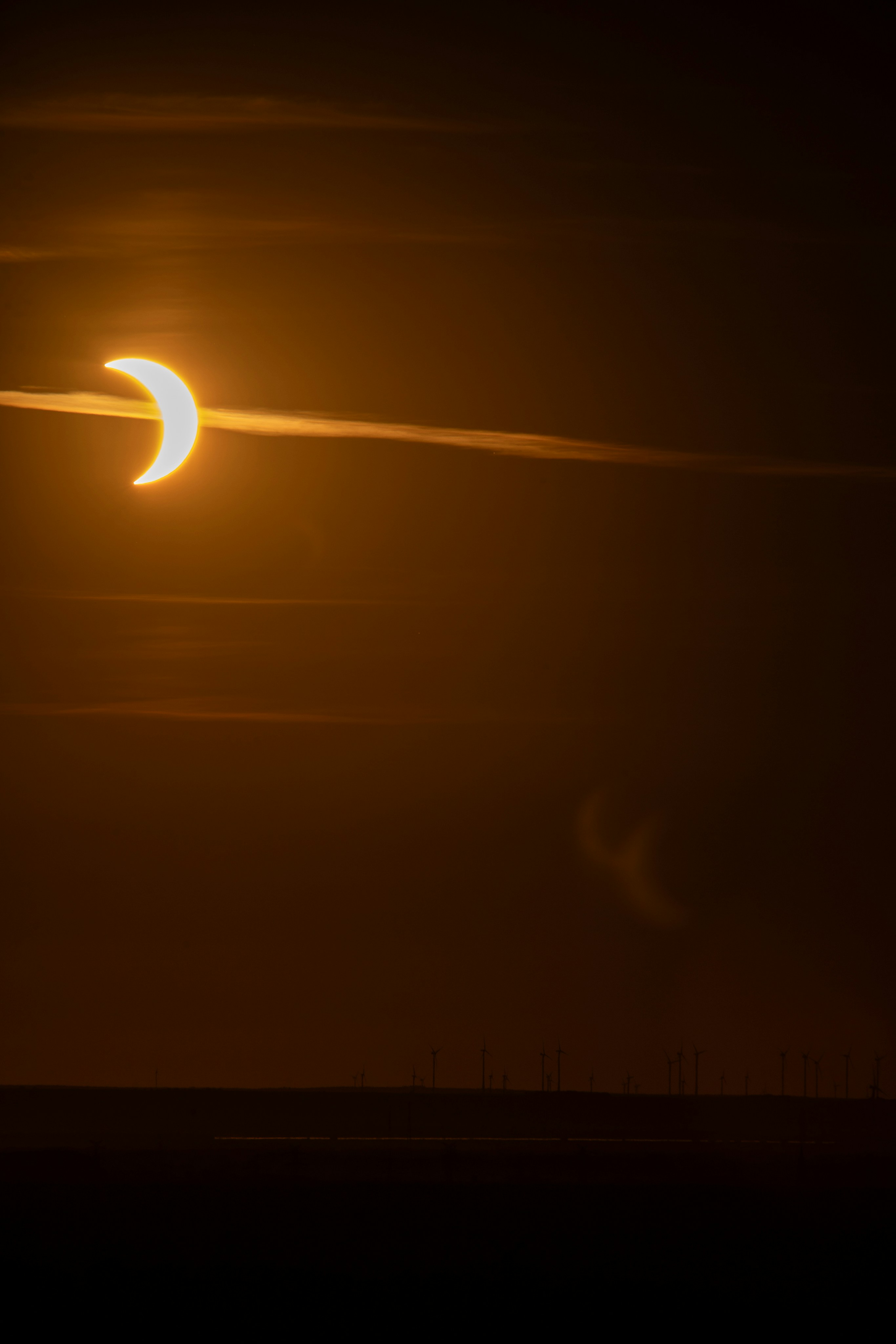 Crescent Eclipse Over Quiet Horizon