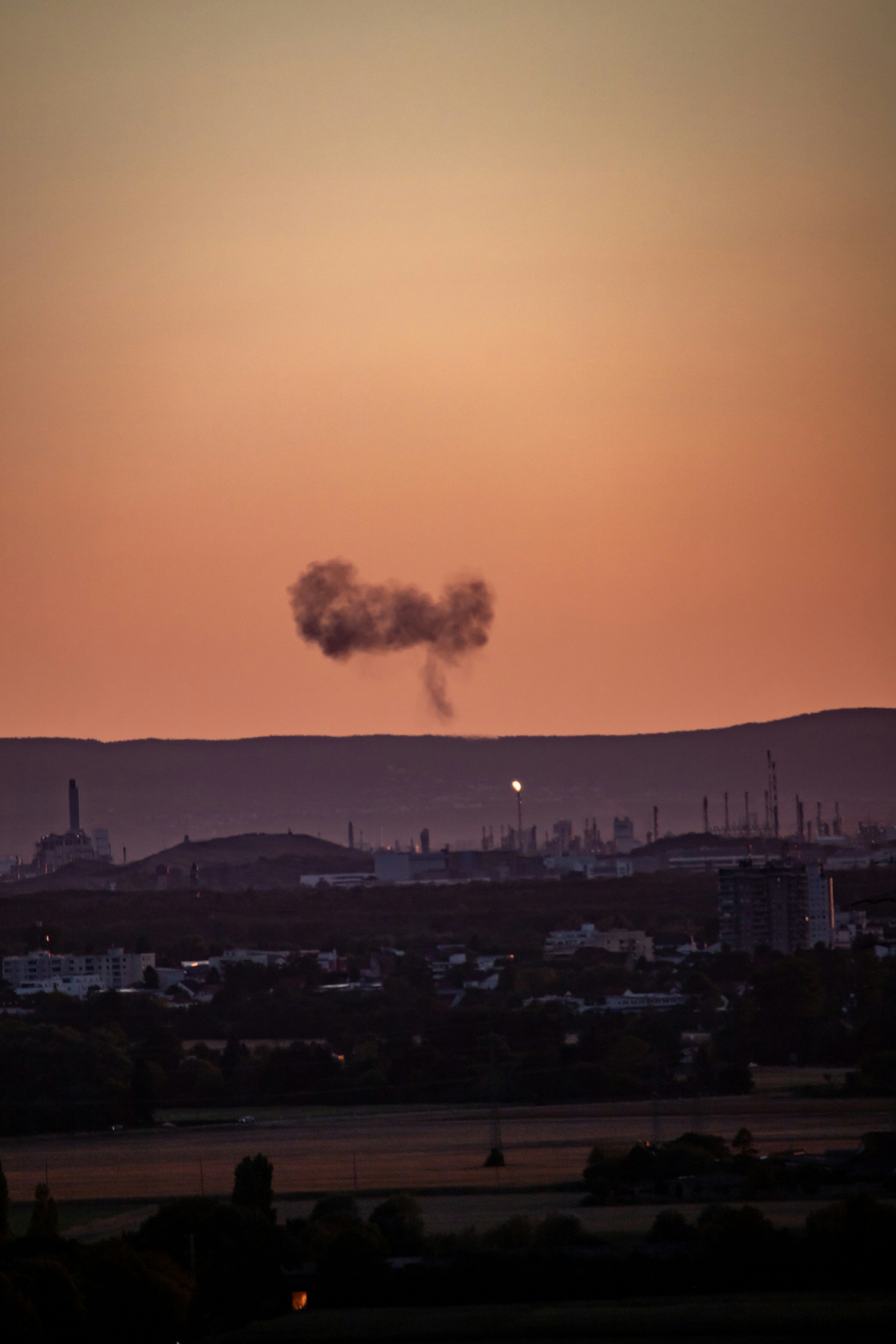 Dusk over the Industrial Horizon as the Plume Rises