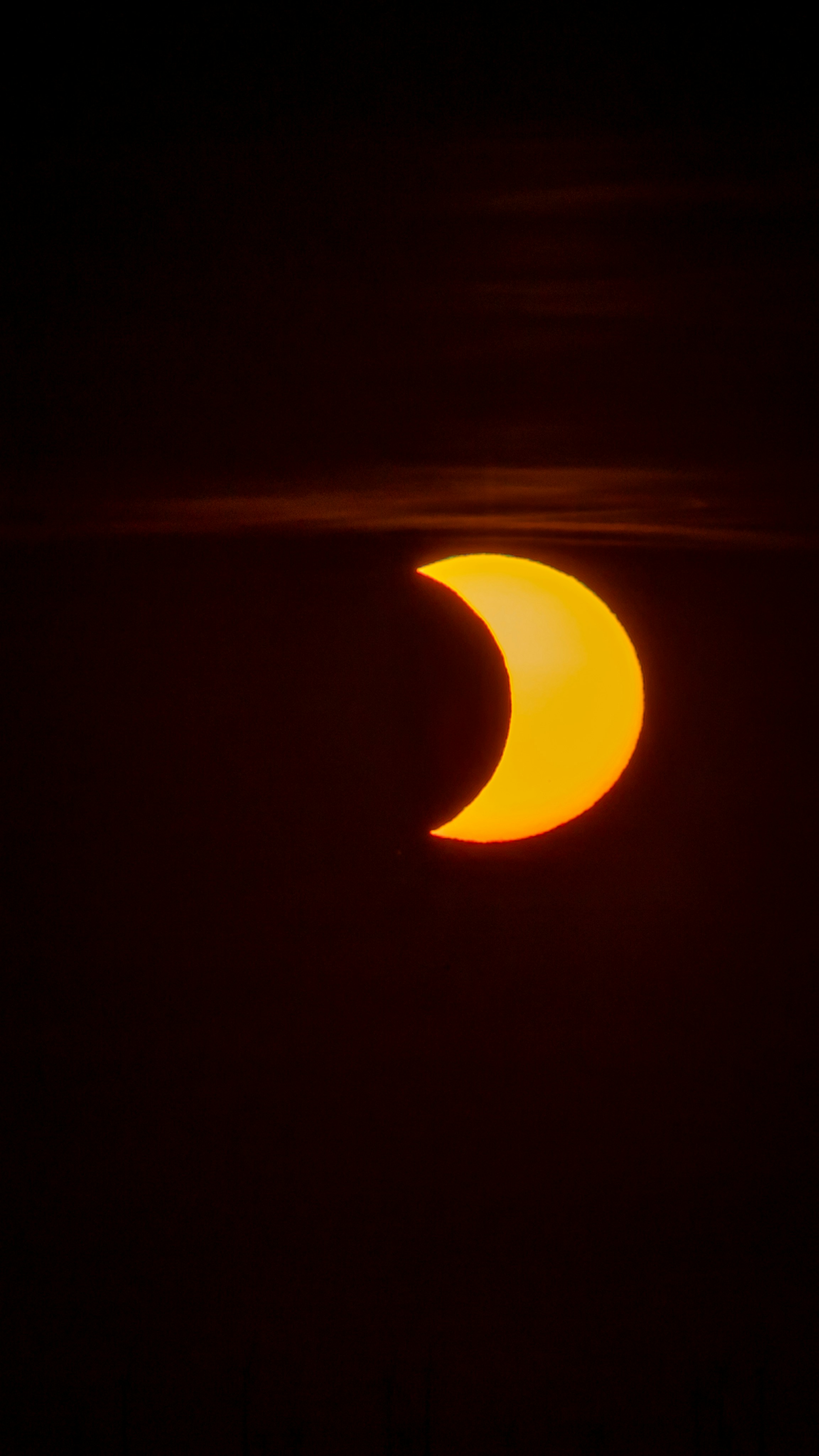 Solitary Crescent: A Lunar Sliver Amid Dark Skies
