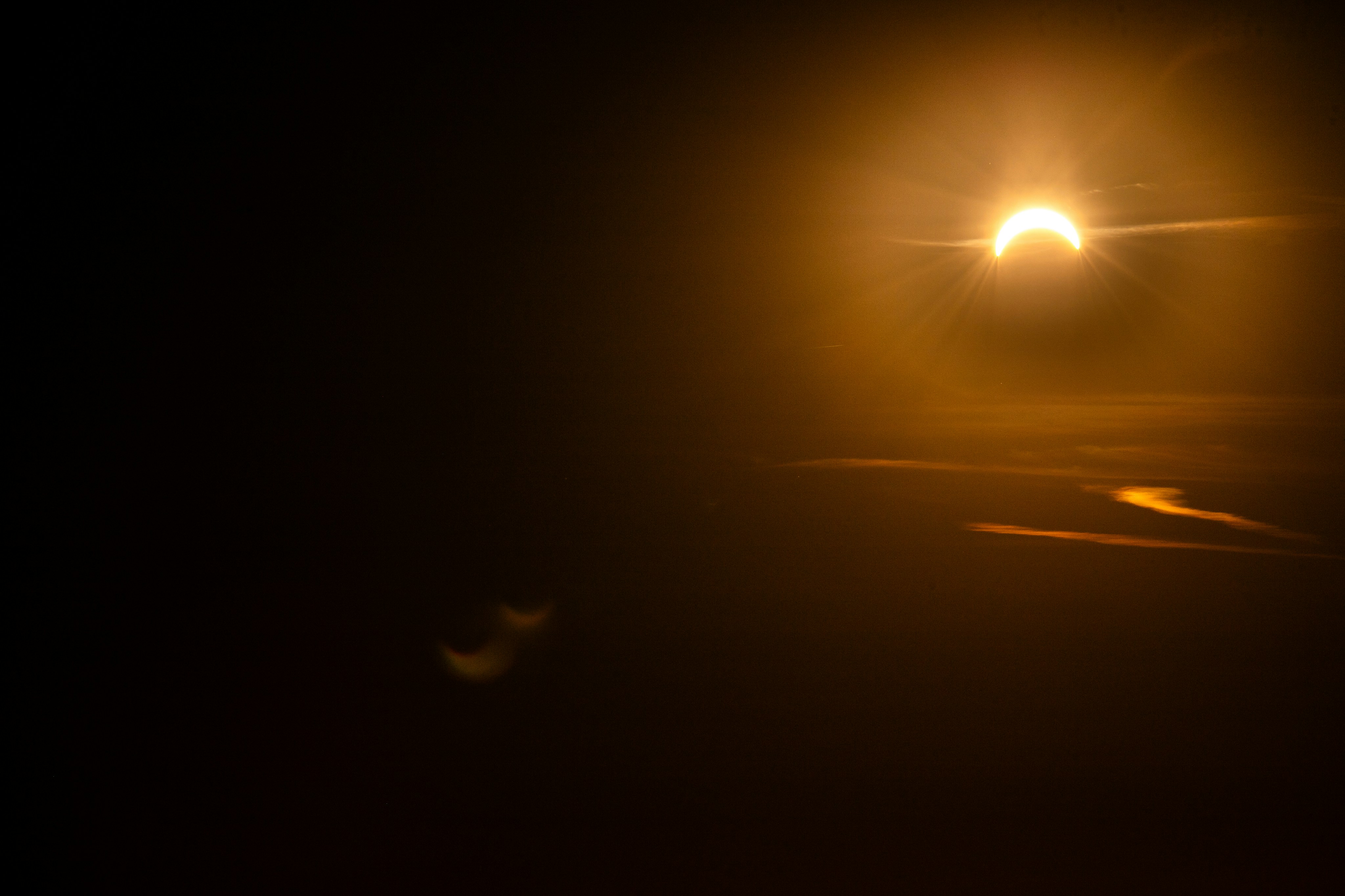 Solar Crescent in Night Sky: A Glowing Arc Amid Darkness
