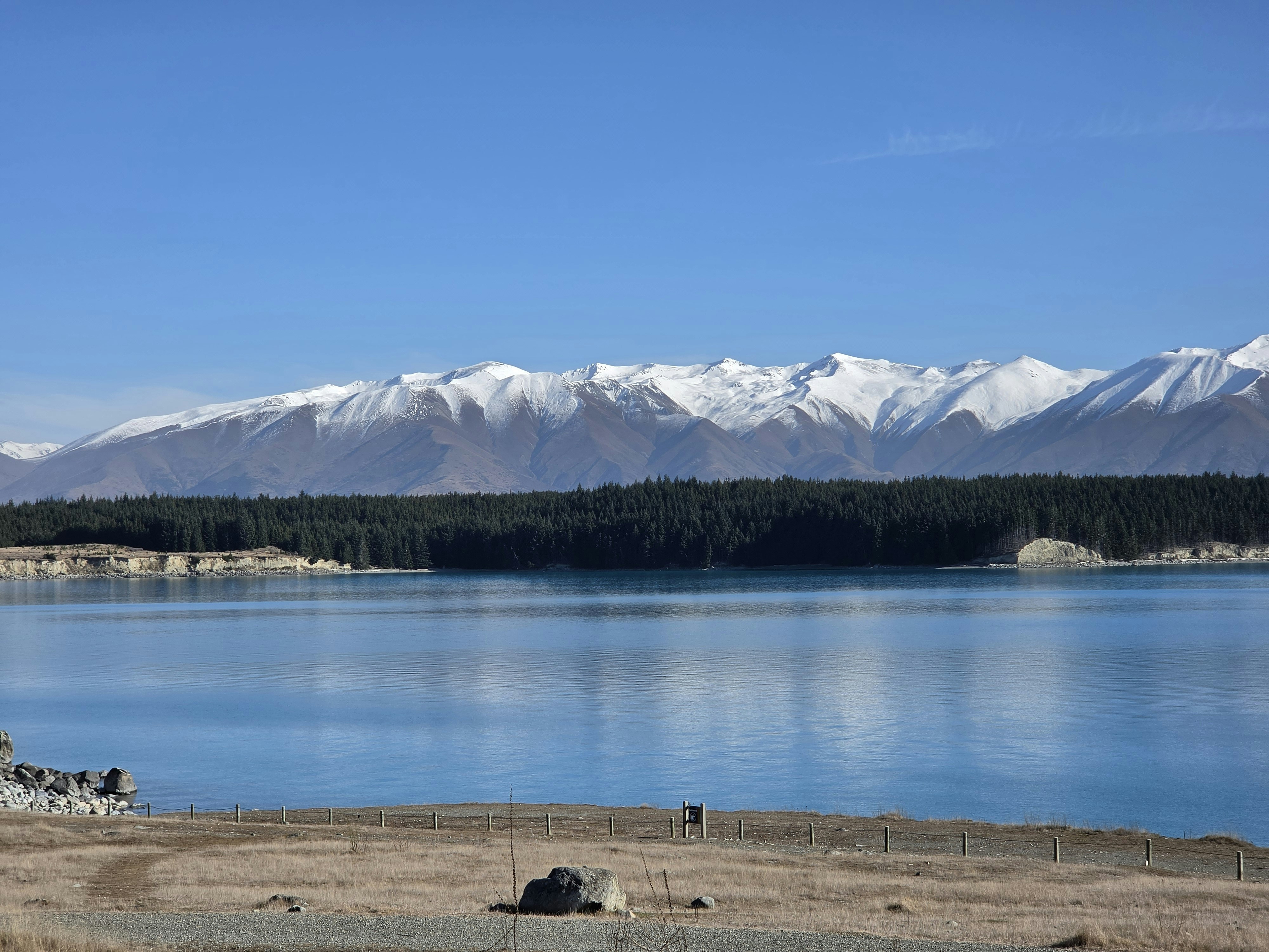 Glacial Ridge Across a Quiet Inland Lake at Noon