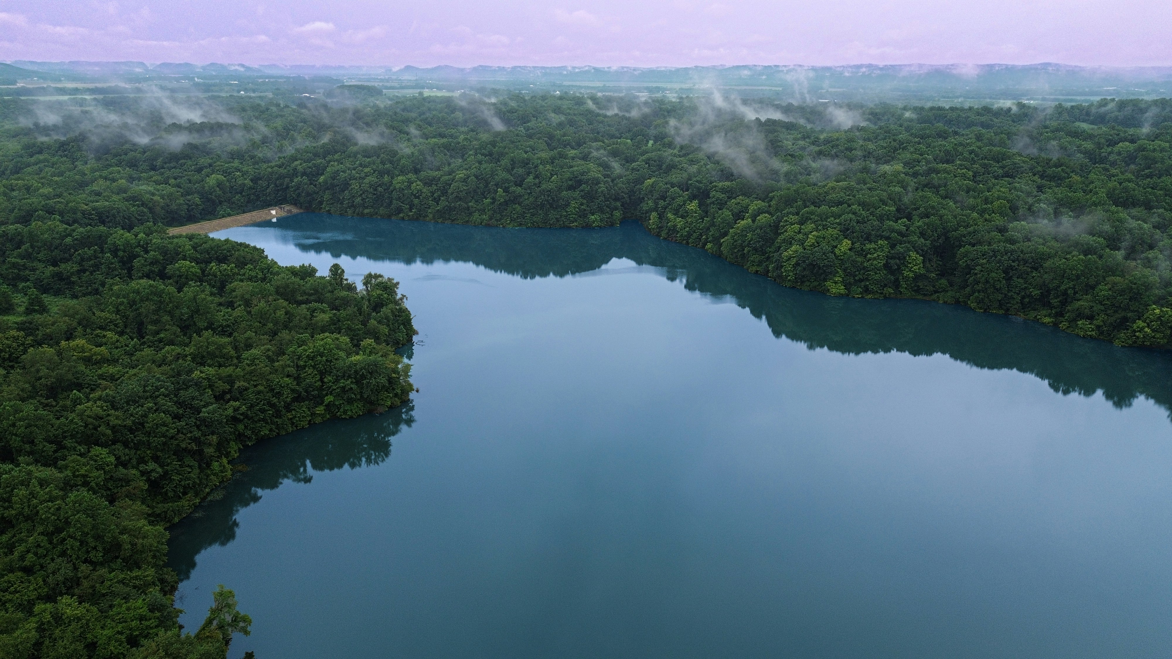 A Quiet Bend: Aerial View Over a Serene Forest-Cilled Lake