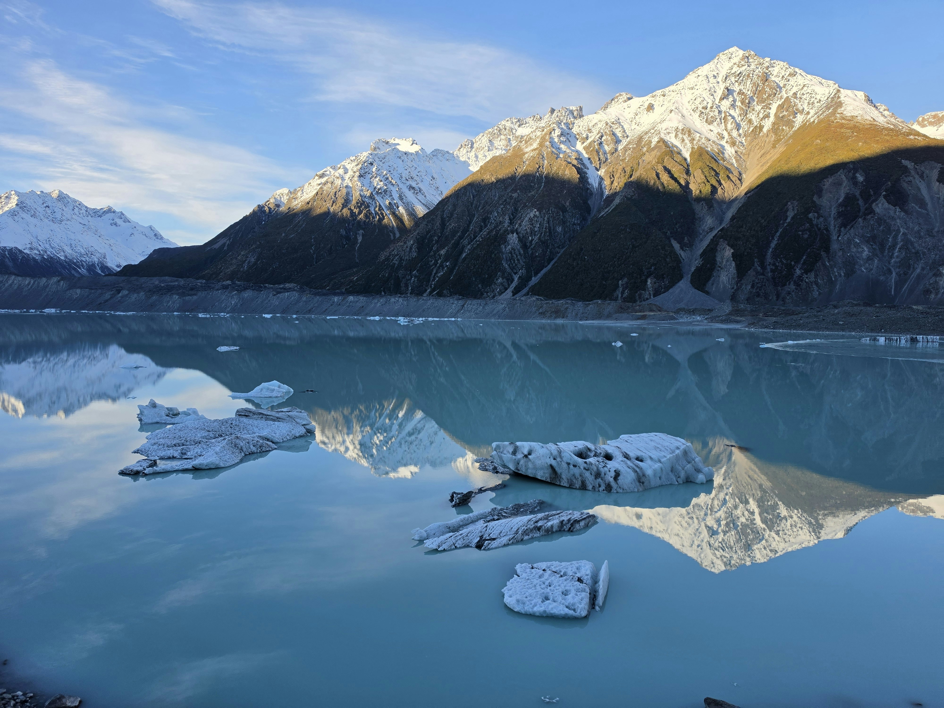 Ice and Peak Reflections Over a Glacier Lake
