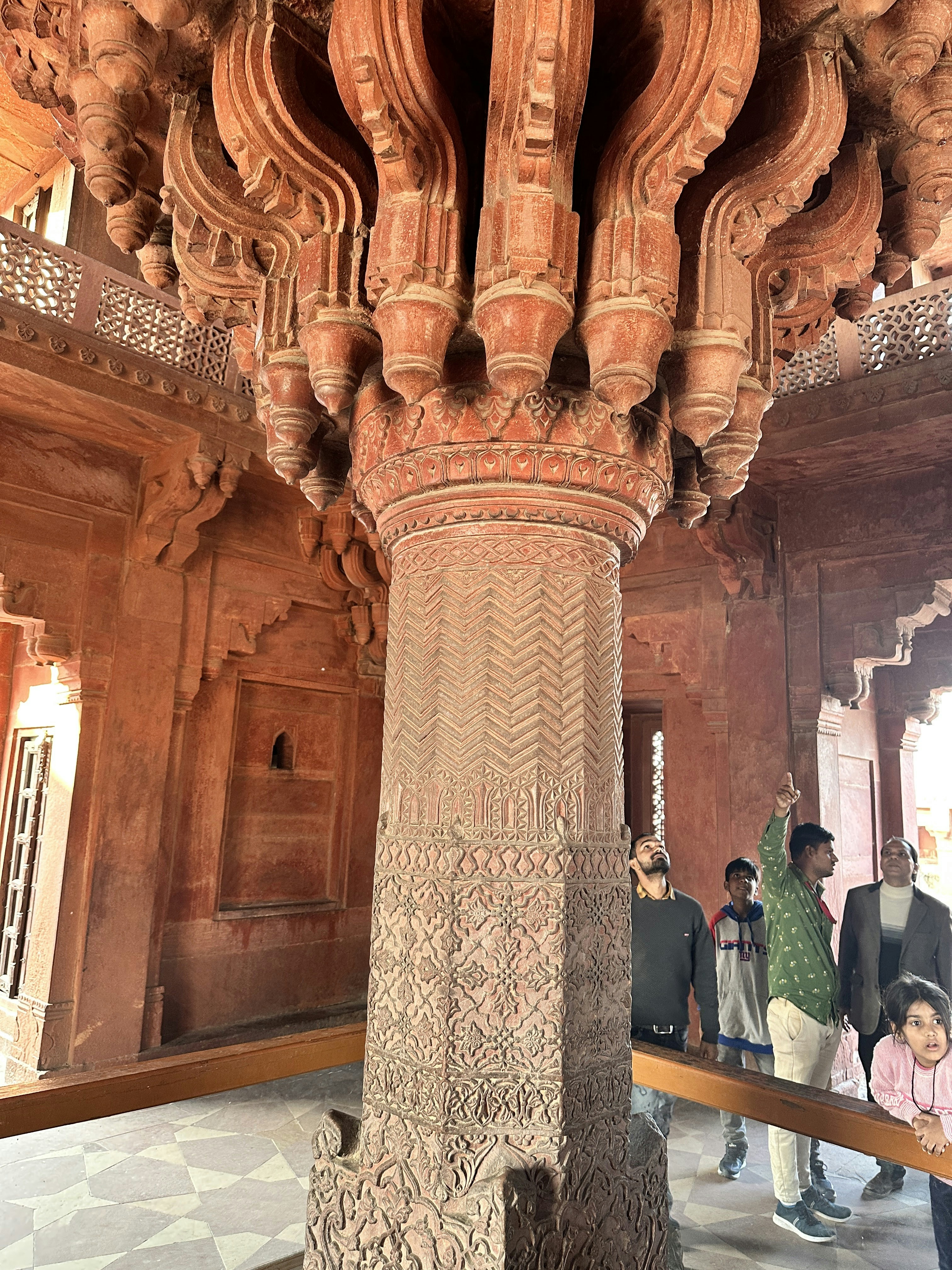 Carved Column at the Center of a Red Sandstone Hall