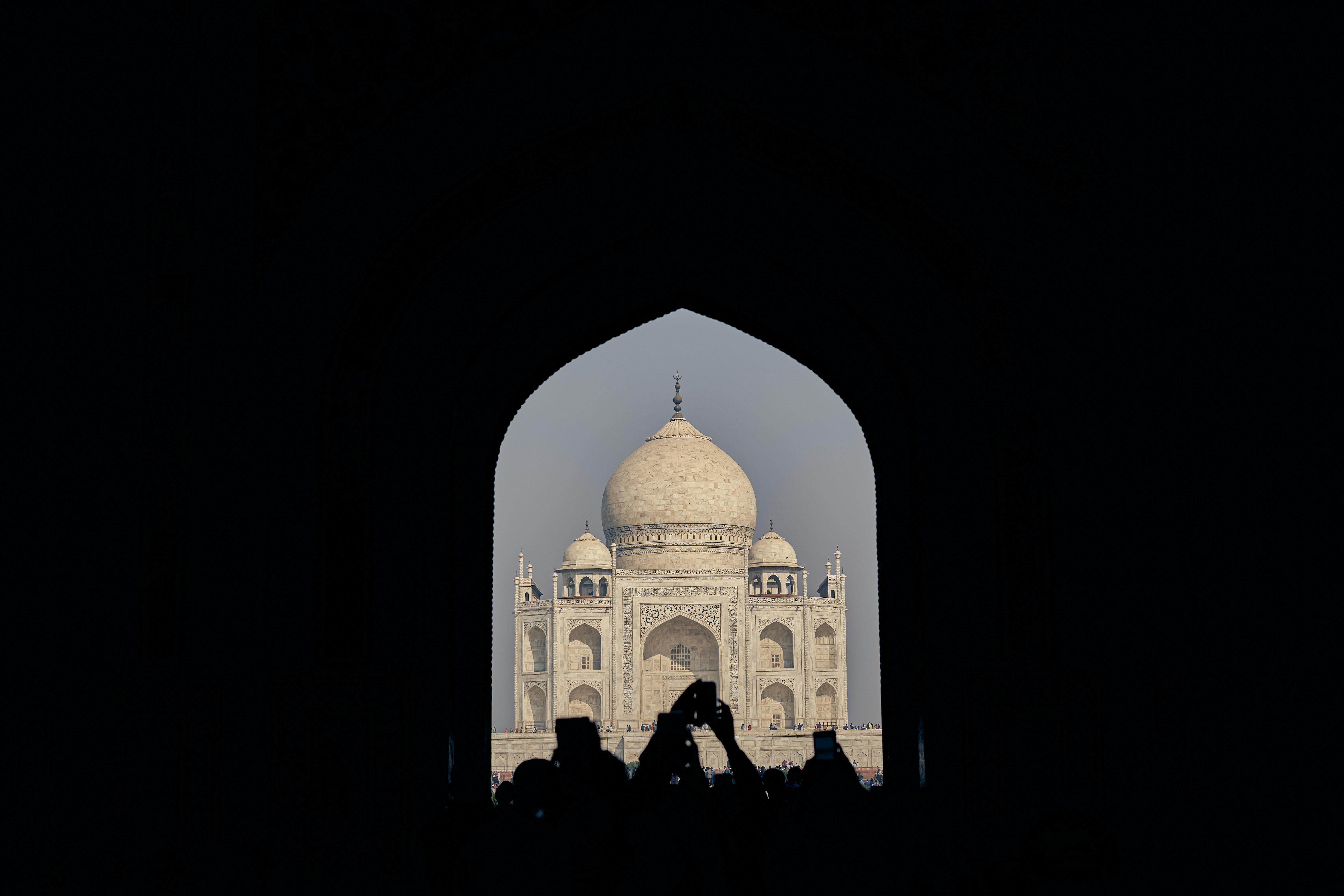 Gateway to the Taj: silhouette framing the marble mausoleum