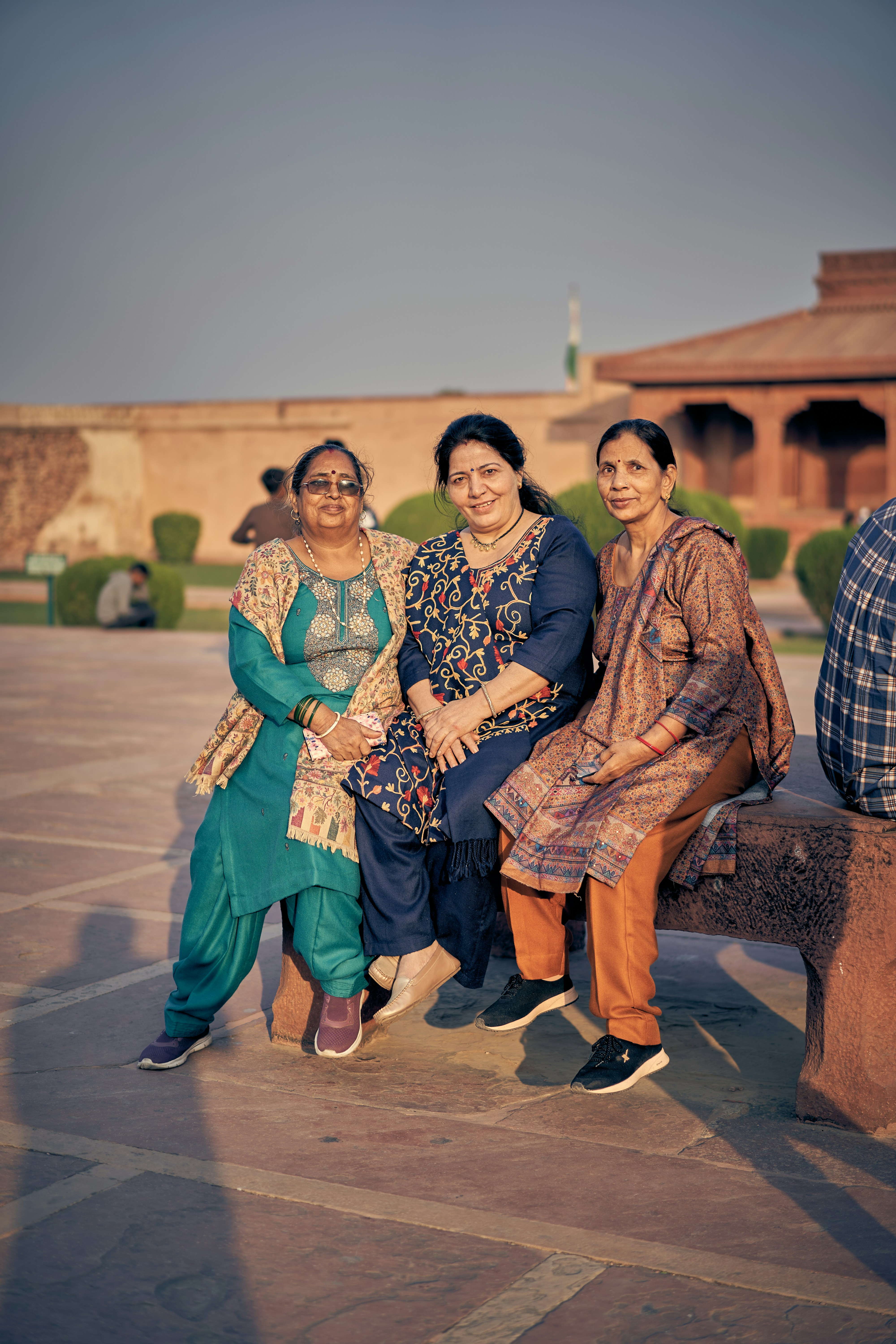 Three Friends on a Stone Bench at a Historic Site
