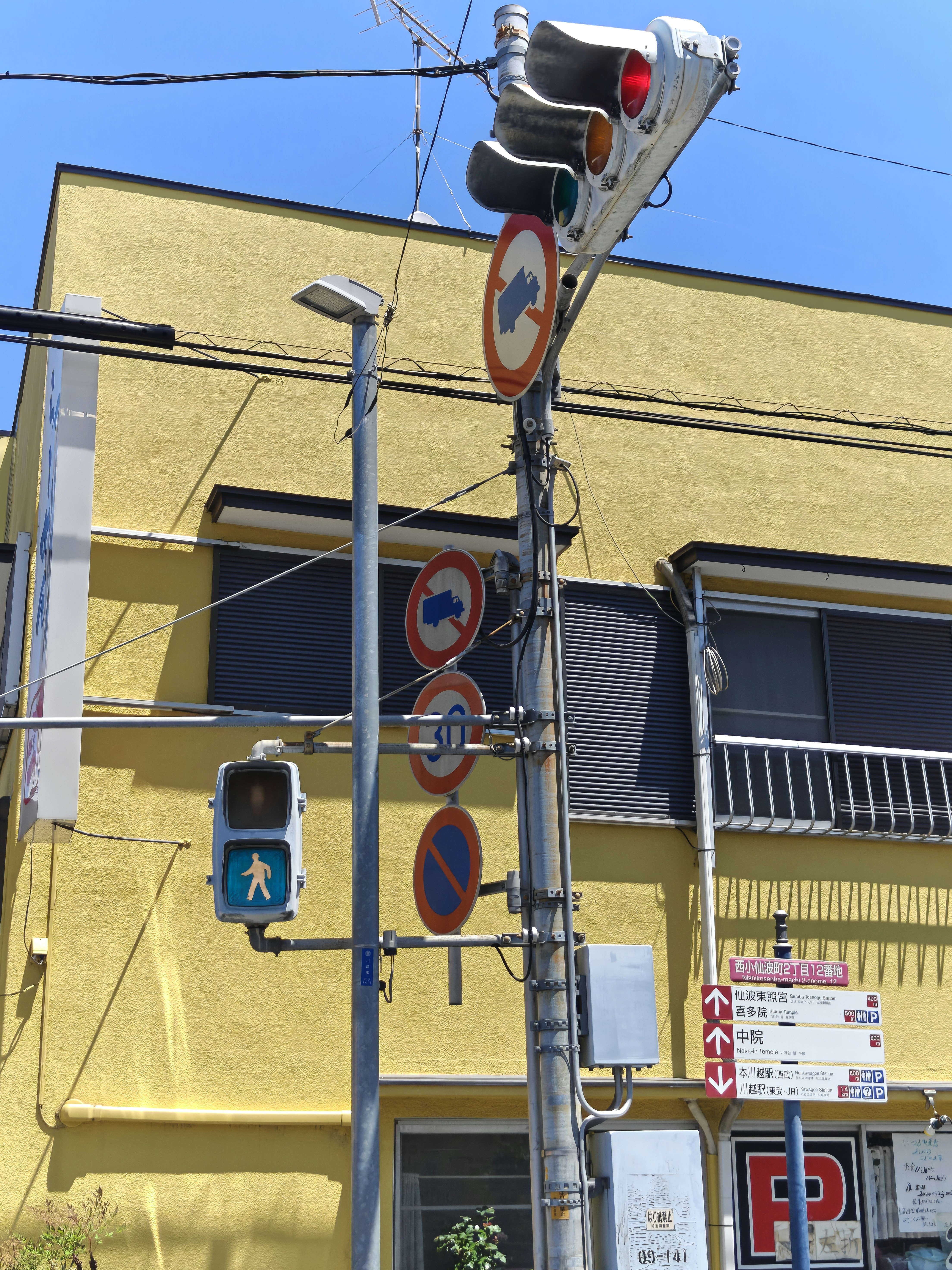 Urban Signal Lines: A Yellow Building Framed by Utility Poles