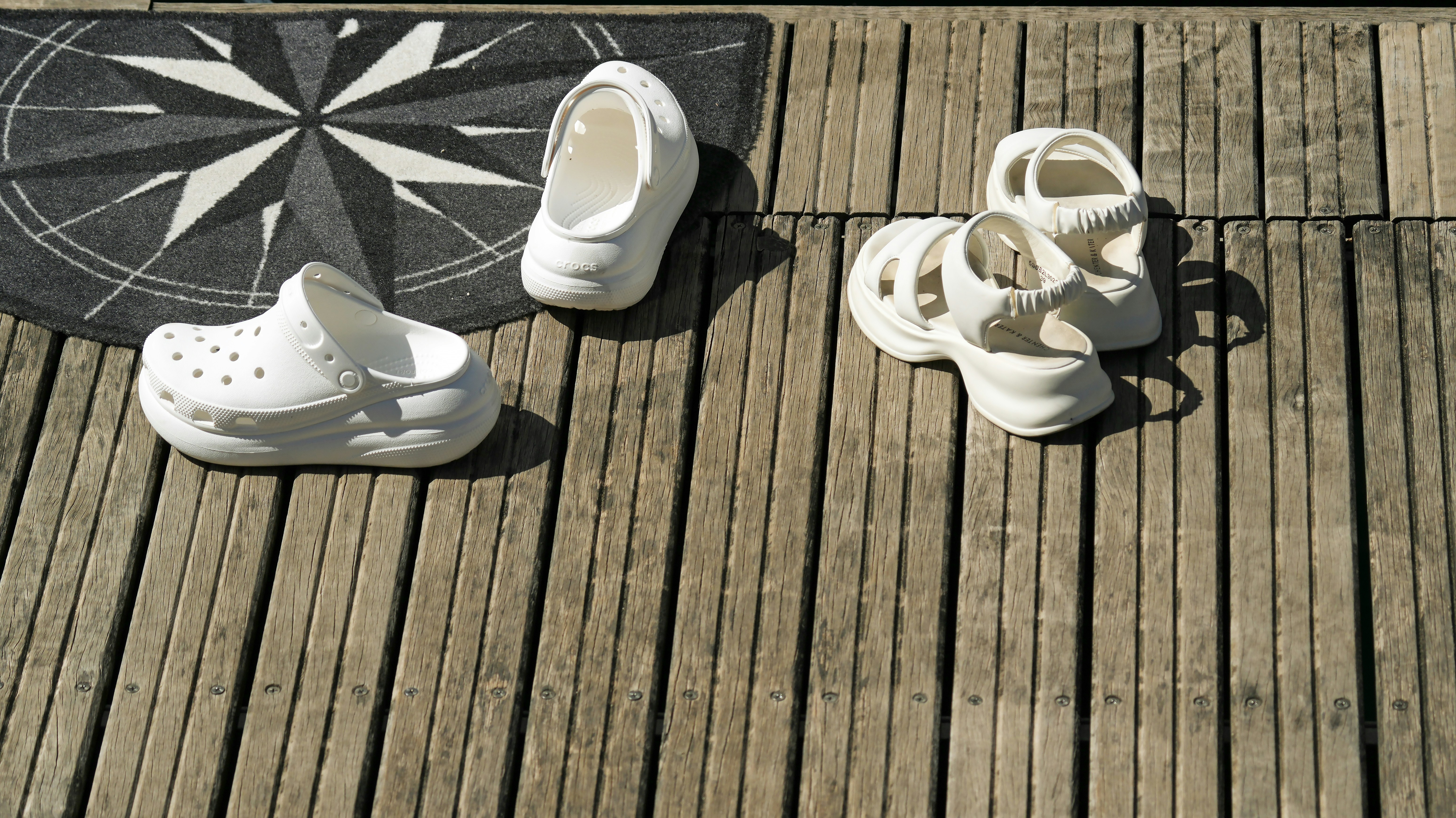 Three White Shoes on a Weathered Deck
