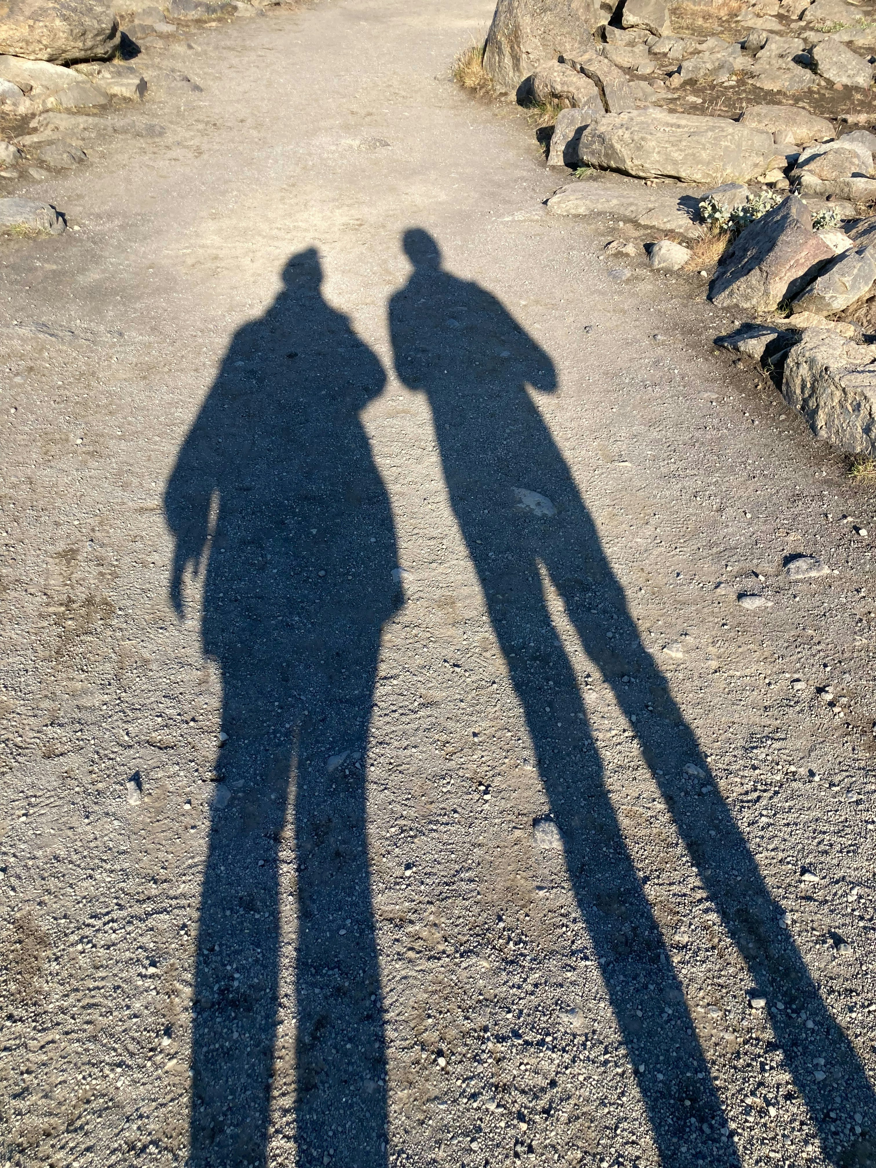 Shadows on a Rough Path: A Pair of Walkers Cast in Late Sun