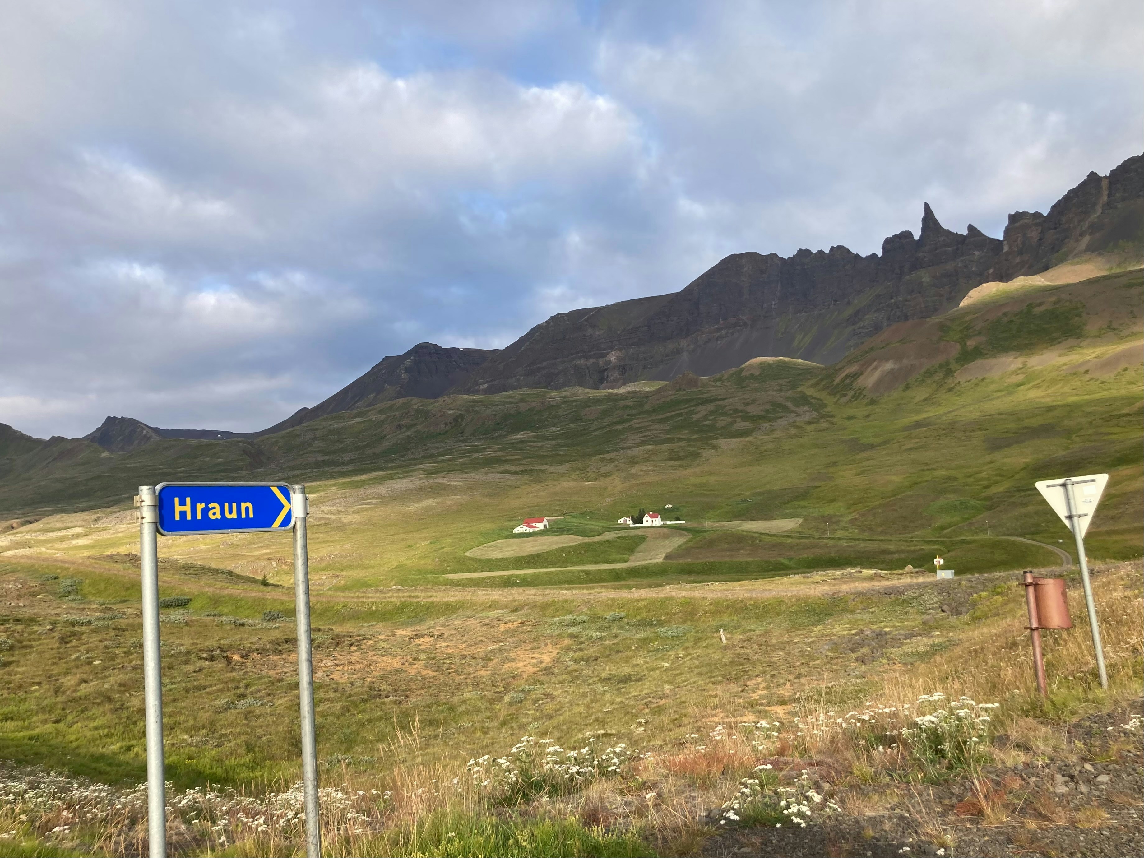 Highland crossroads: a blue road sign against rolling hills