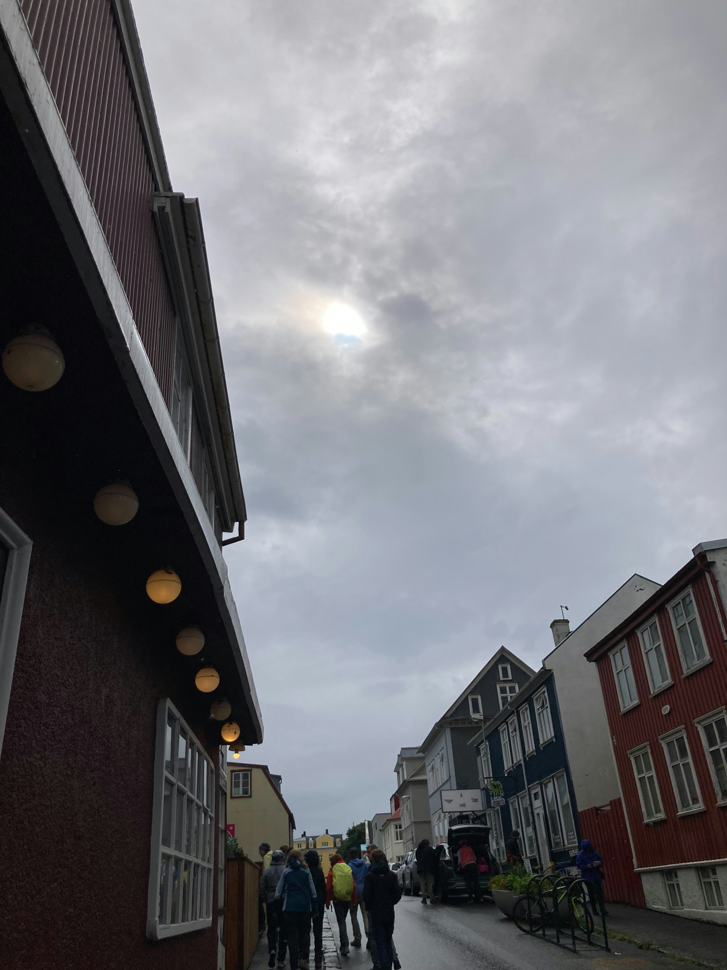 Cloudy Street in a Nordic Village with Shoppers Under Overhang Lights