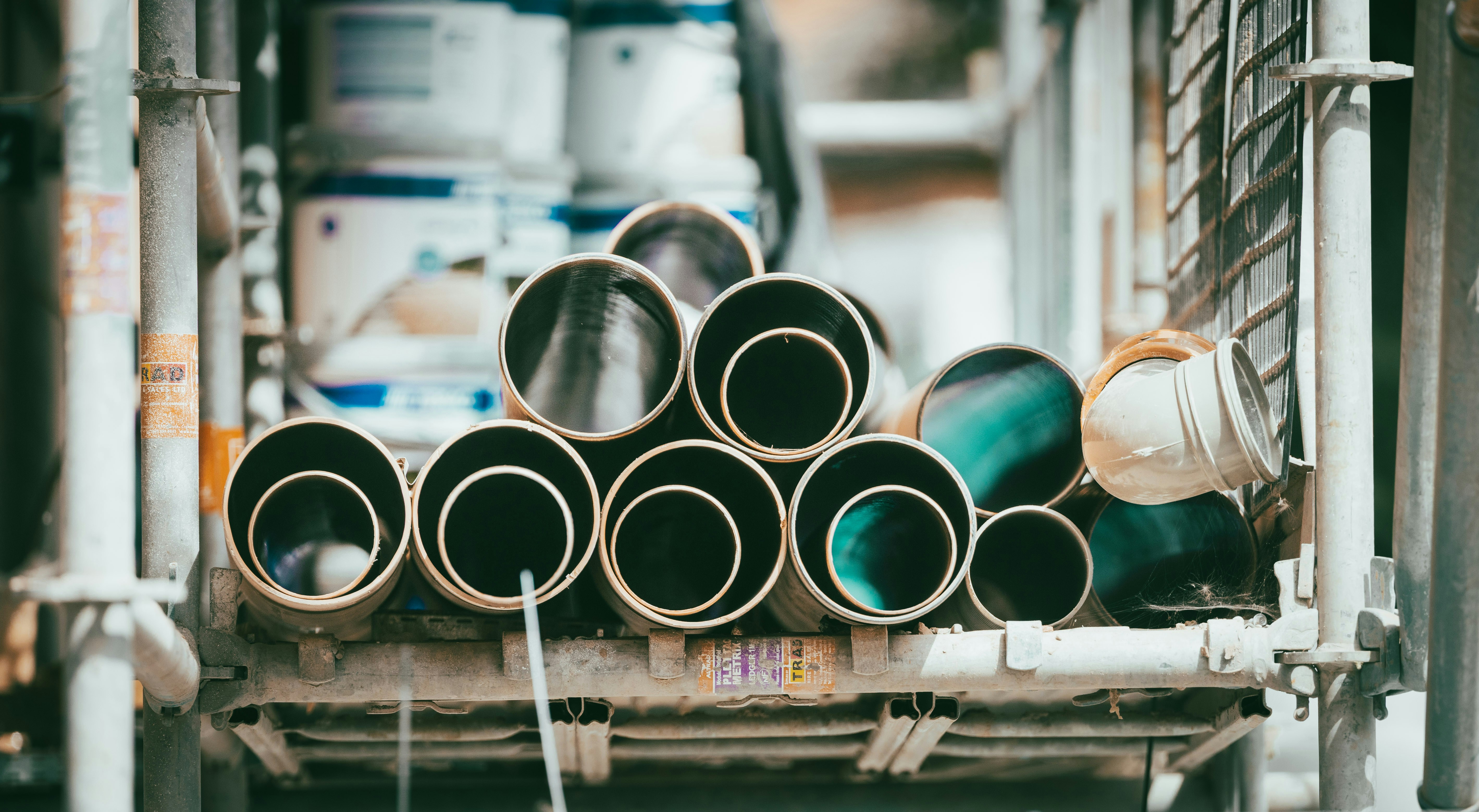 Stacked Industrial Pipes: Framed Rows of Cylinders on a Scaffold