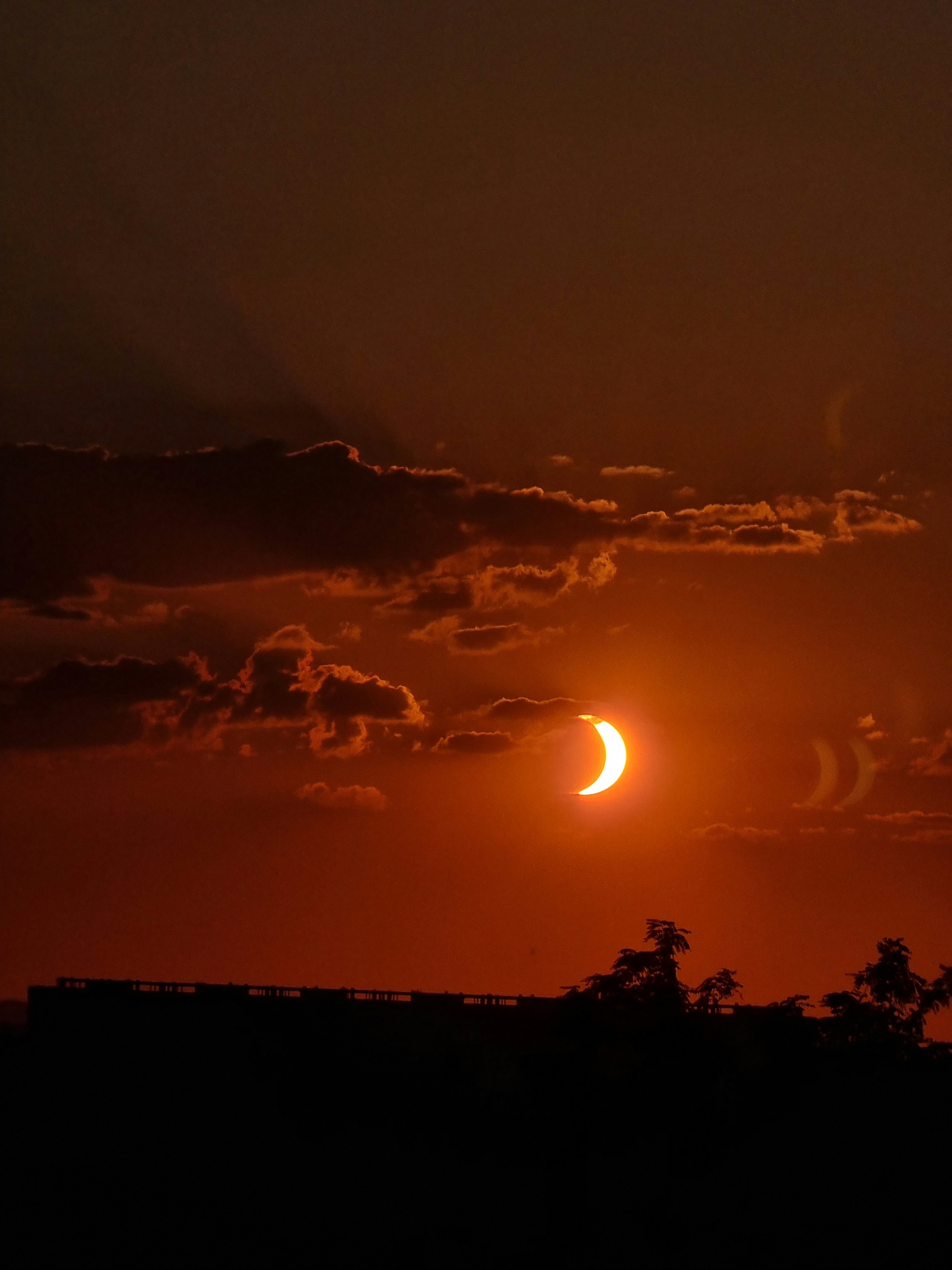 Crescent Fire: a solar eclipse glow over a silent horizon