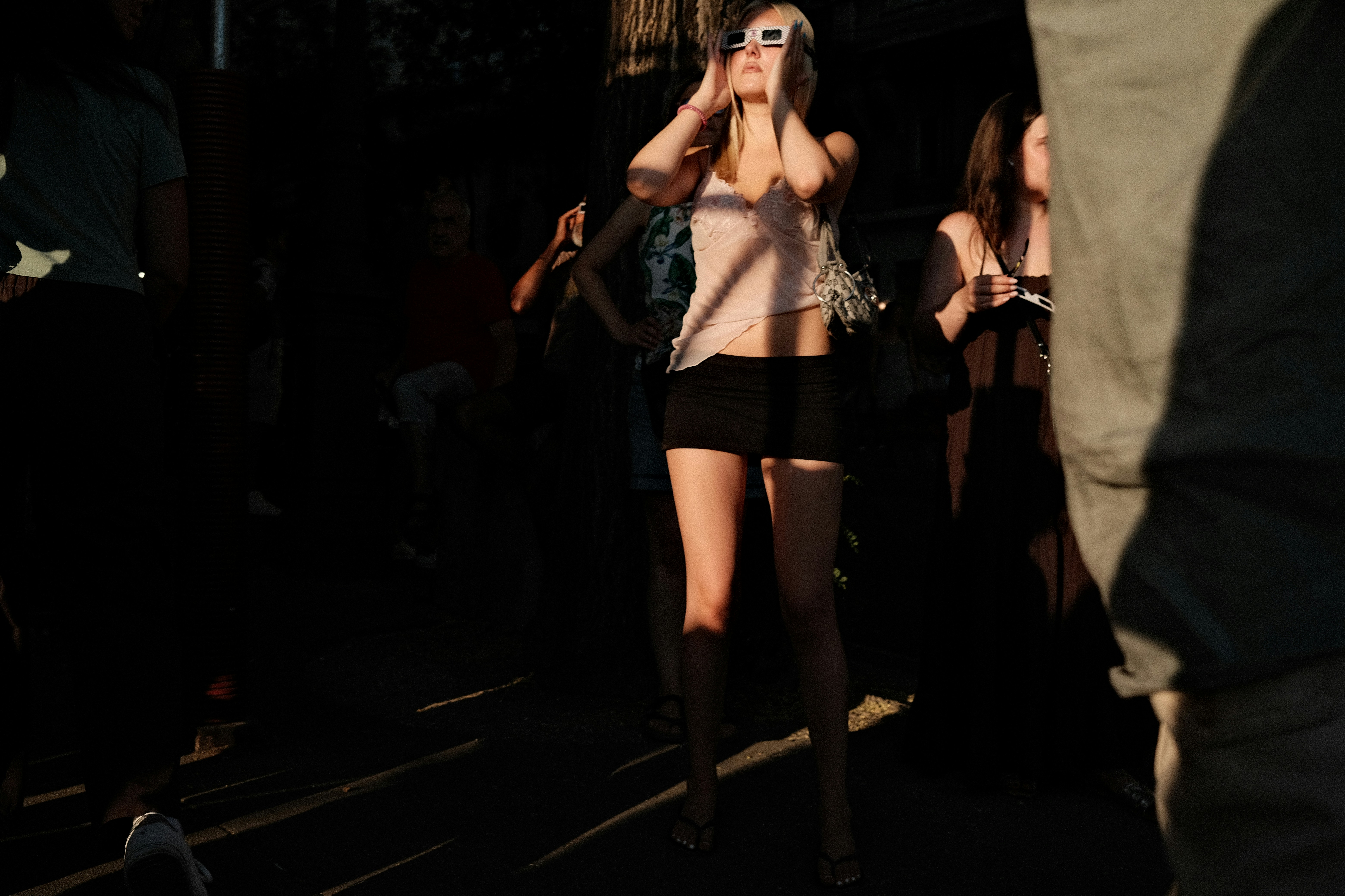 Spotlight at the Night Market: A Central Figure Under the Grid of Shadows