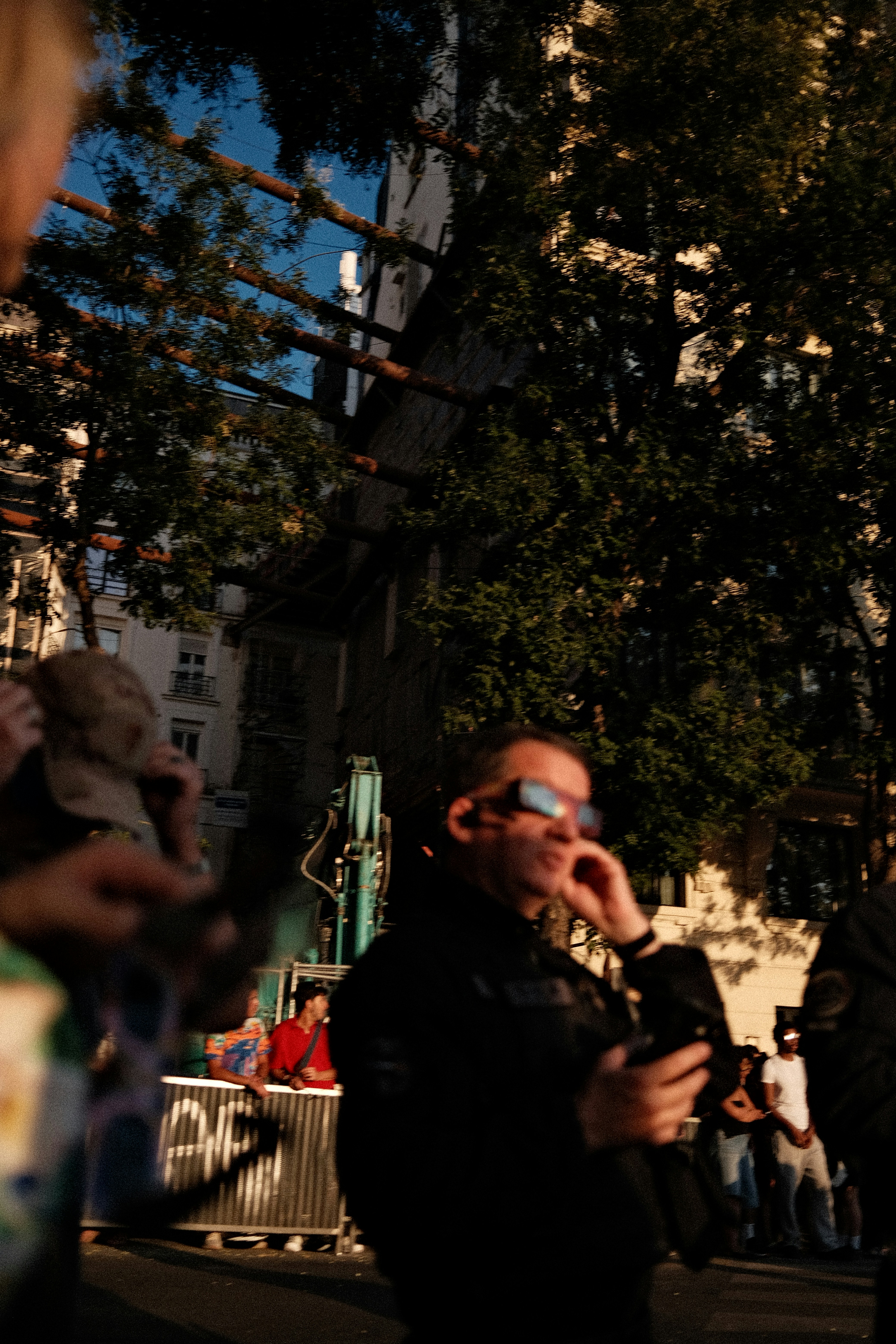 Mid-Urban Moment: The Sunglasses Reflection and Focused Gaze