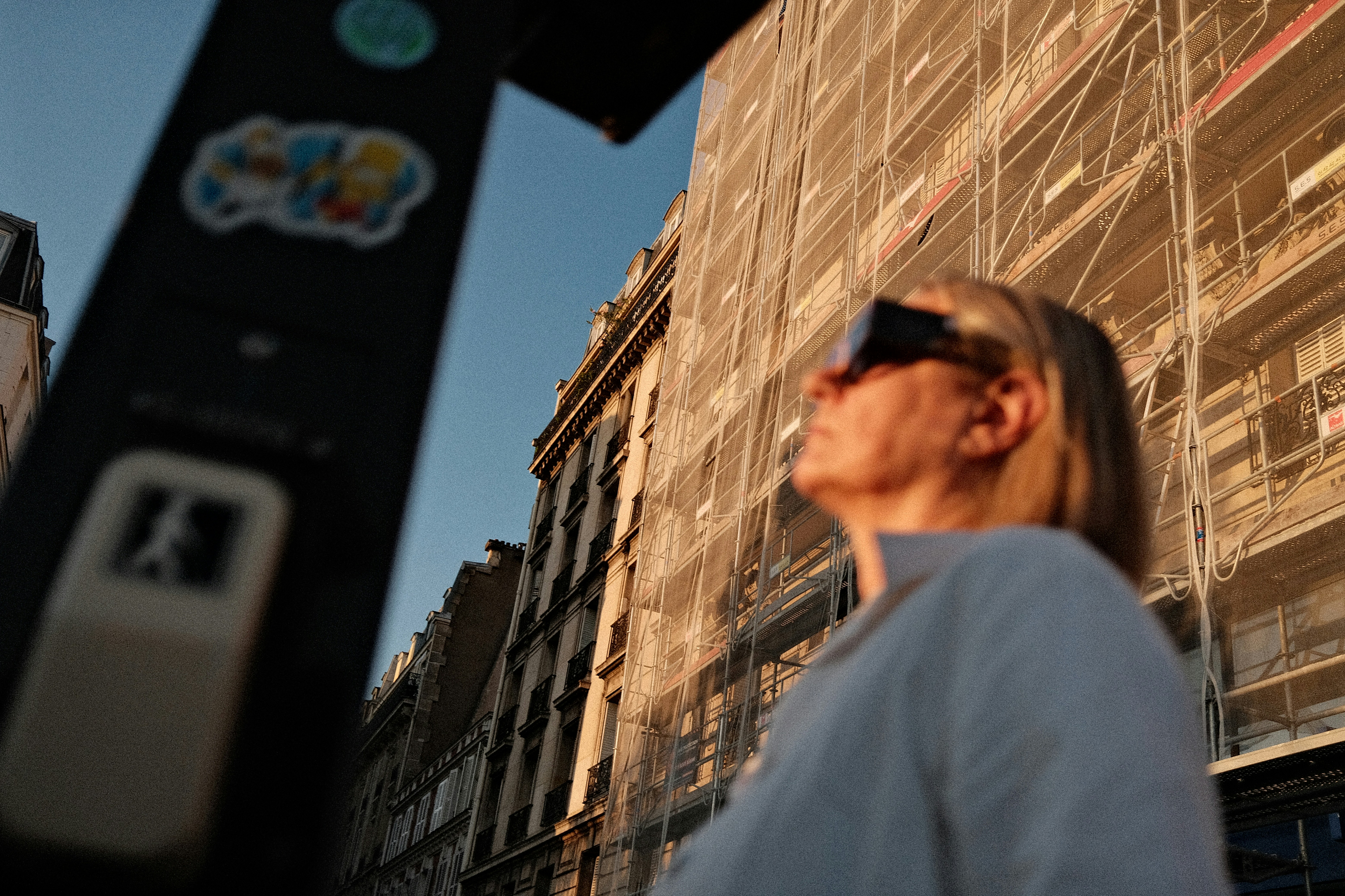 Facing the City: A Woman in the Shadow of Glass and Steel