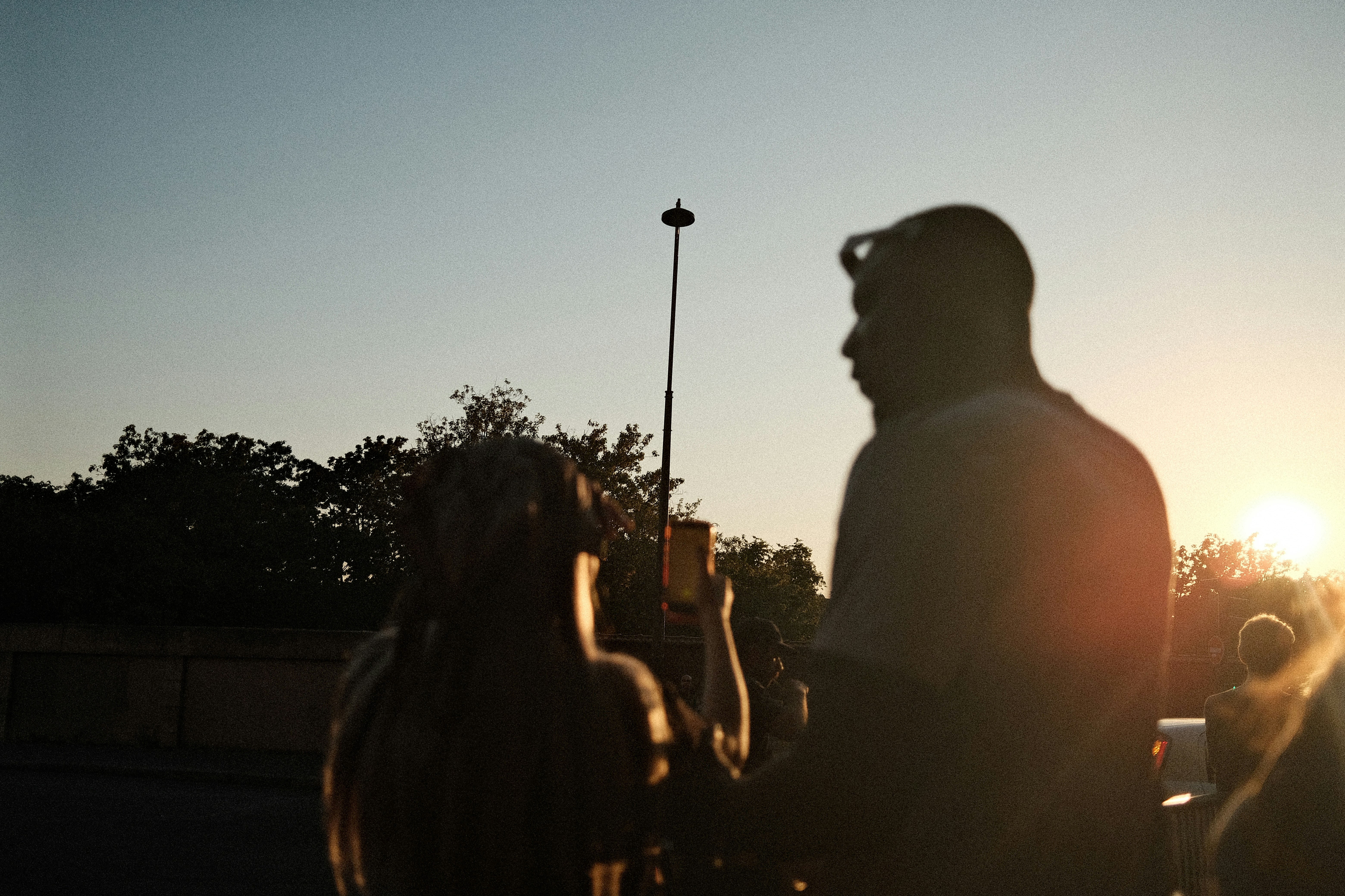 Backlit Reunion: Silhouettes Against a Setting Sun
