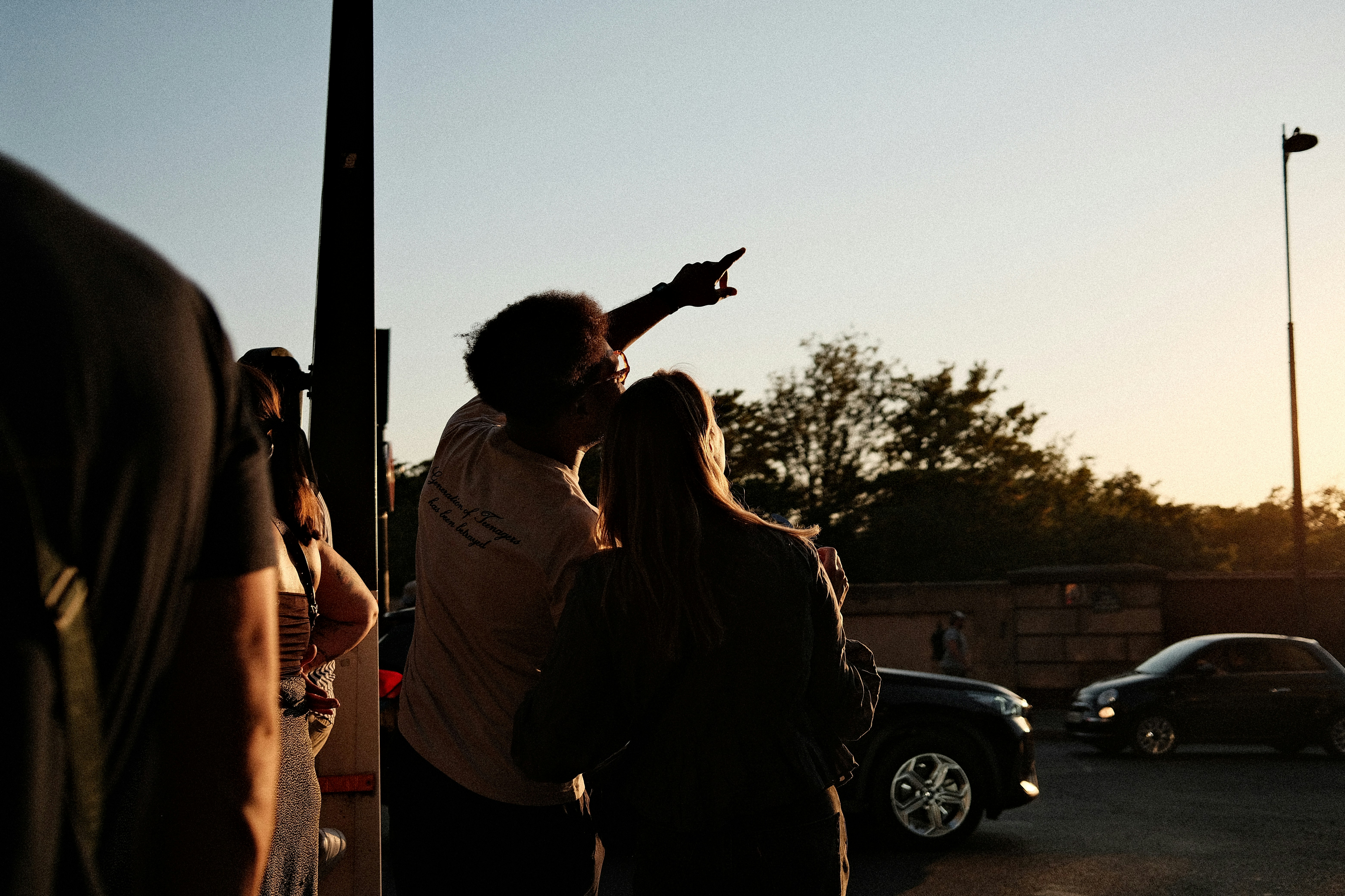 Outstretched Gesture as the Sunset Crowd Watches