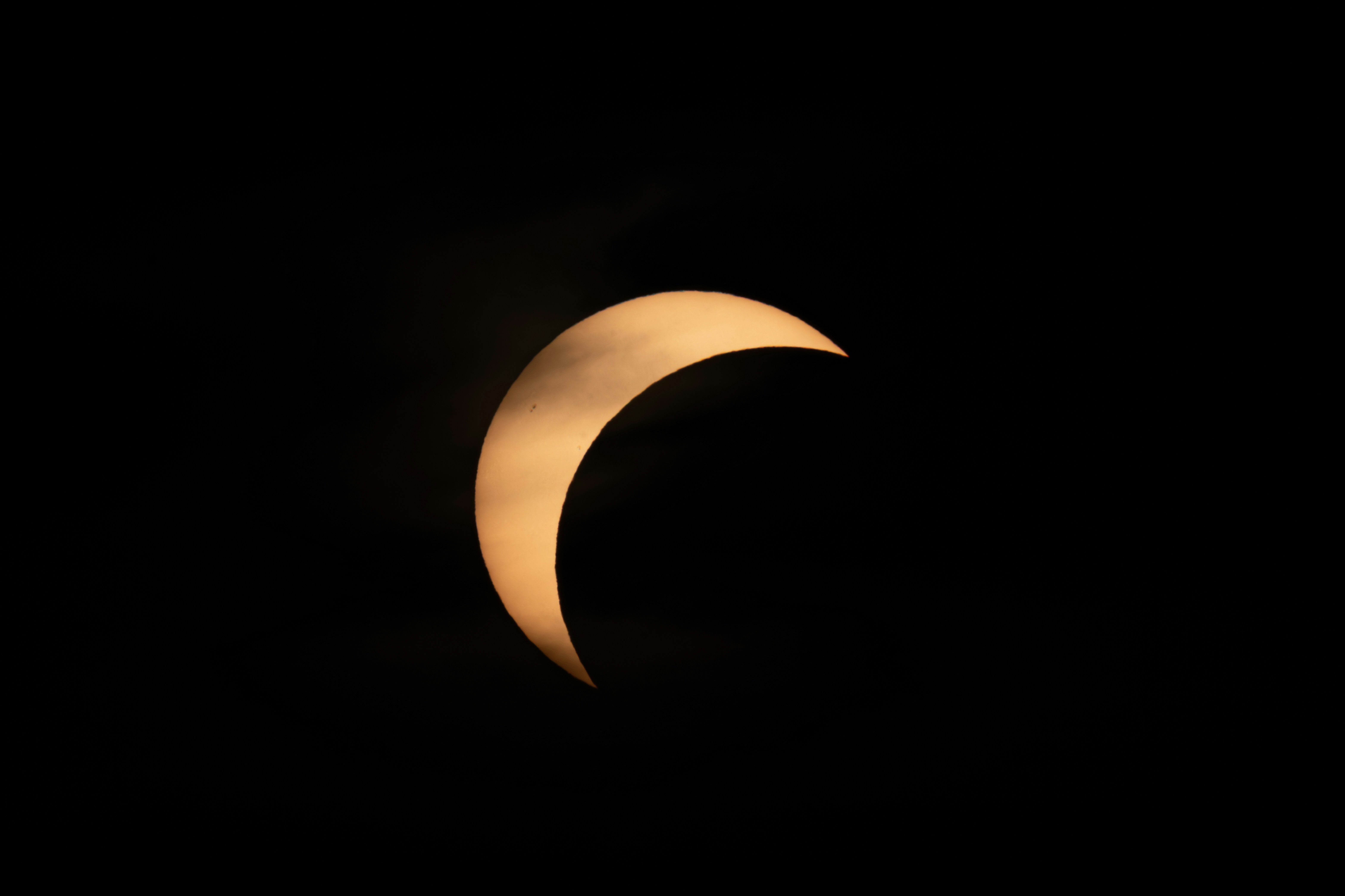 Moon’s partial smile: a lone crescent in the dark