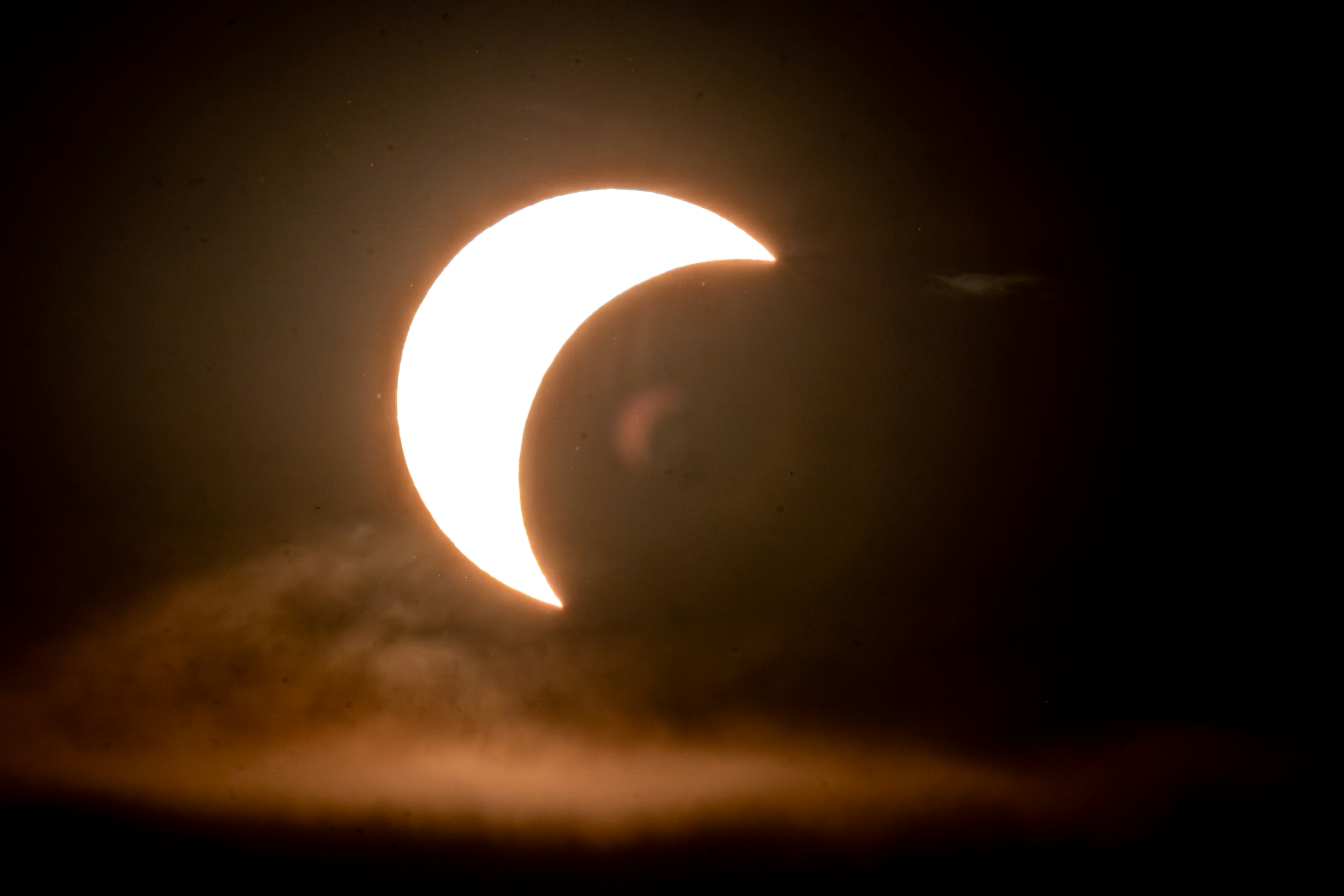 Partial Eclipse: The Sun Burnishes the Night with a Crescent Warmth