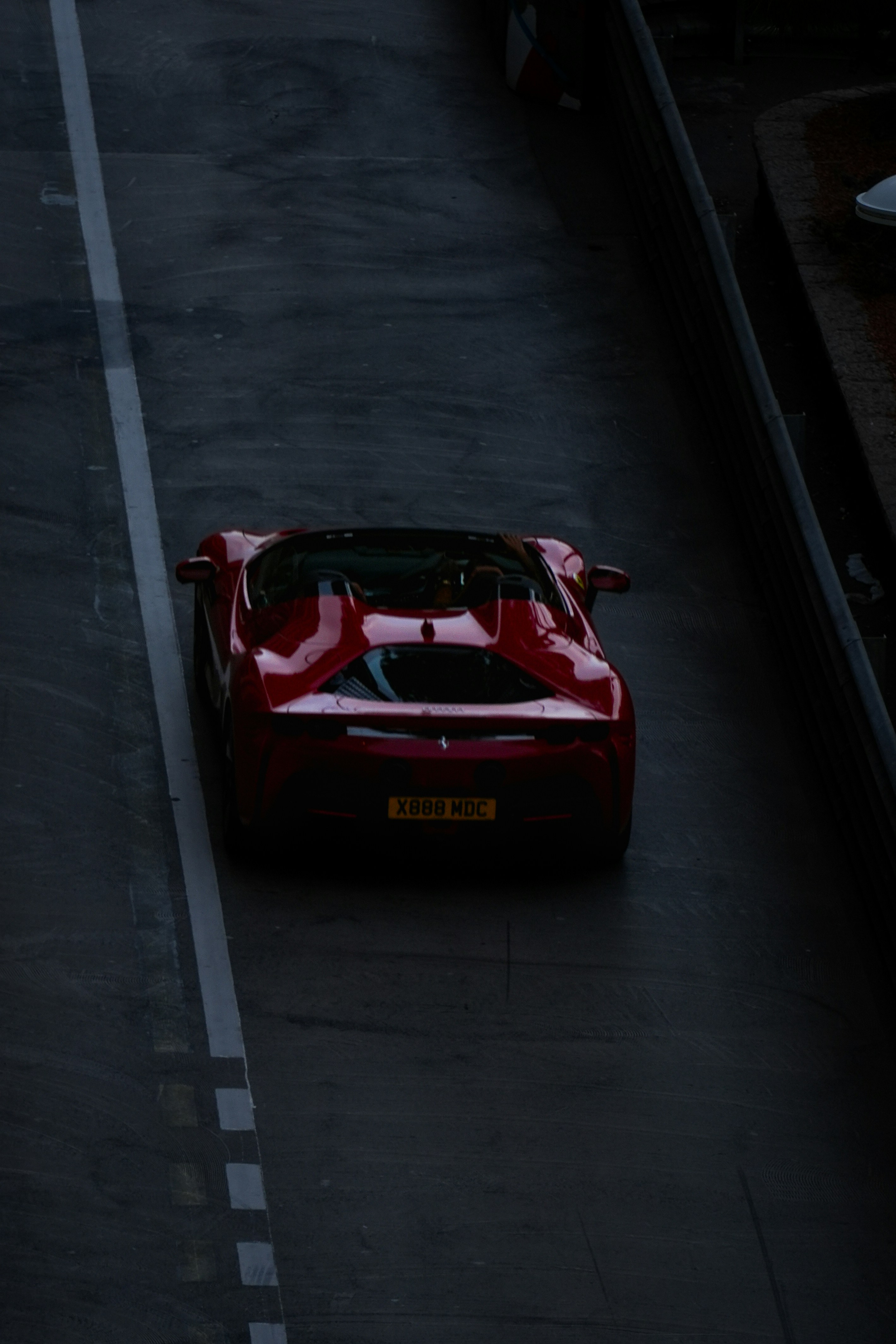 Red Exemplar: A Sports Car Anchored in a Narrow Urban Channel